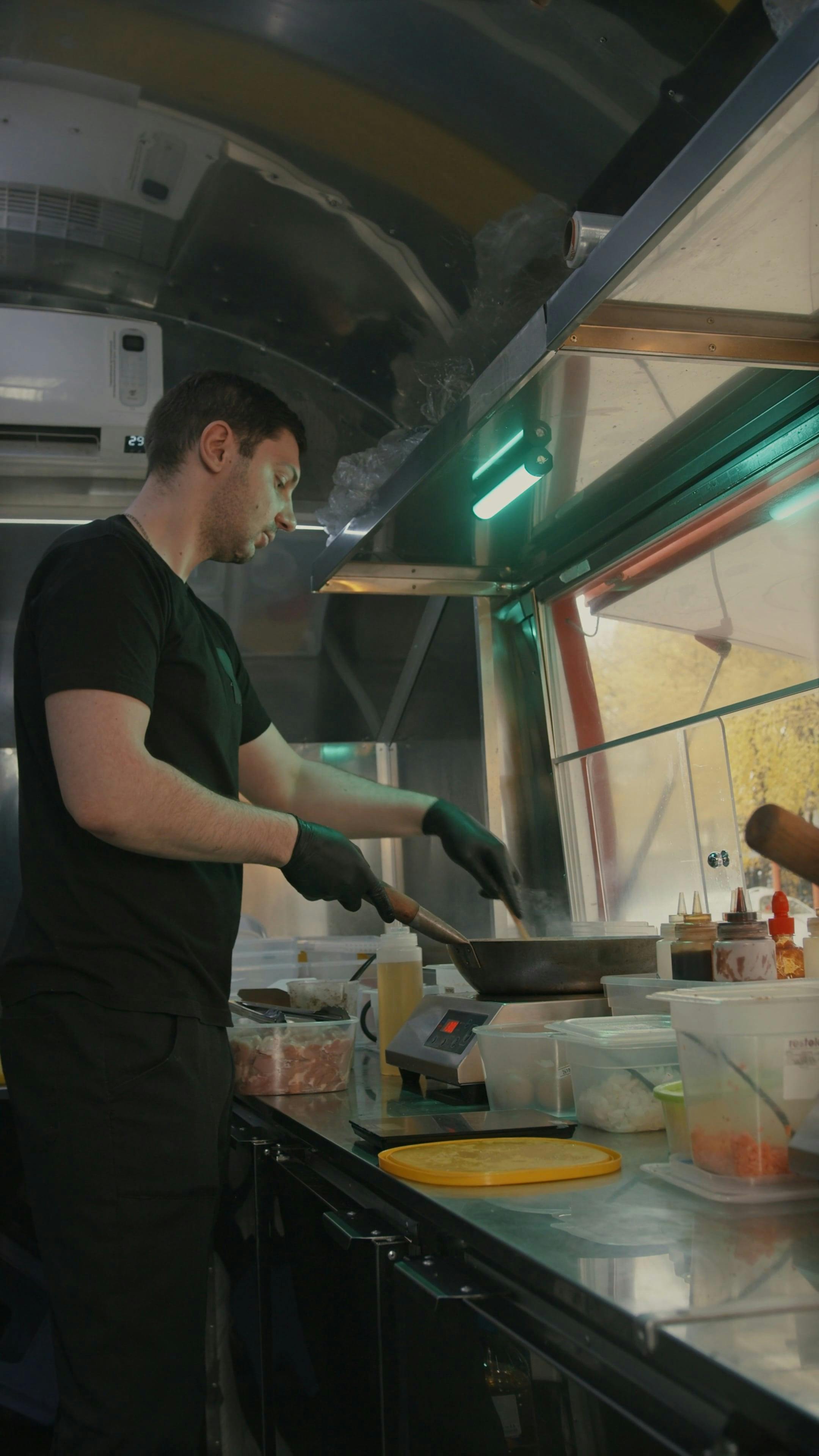 Person Cooking Inside a Food Truck · Free Stock Video