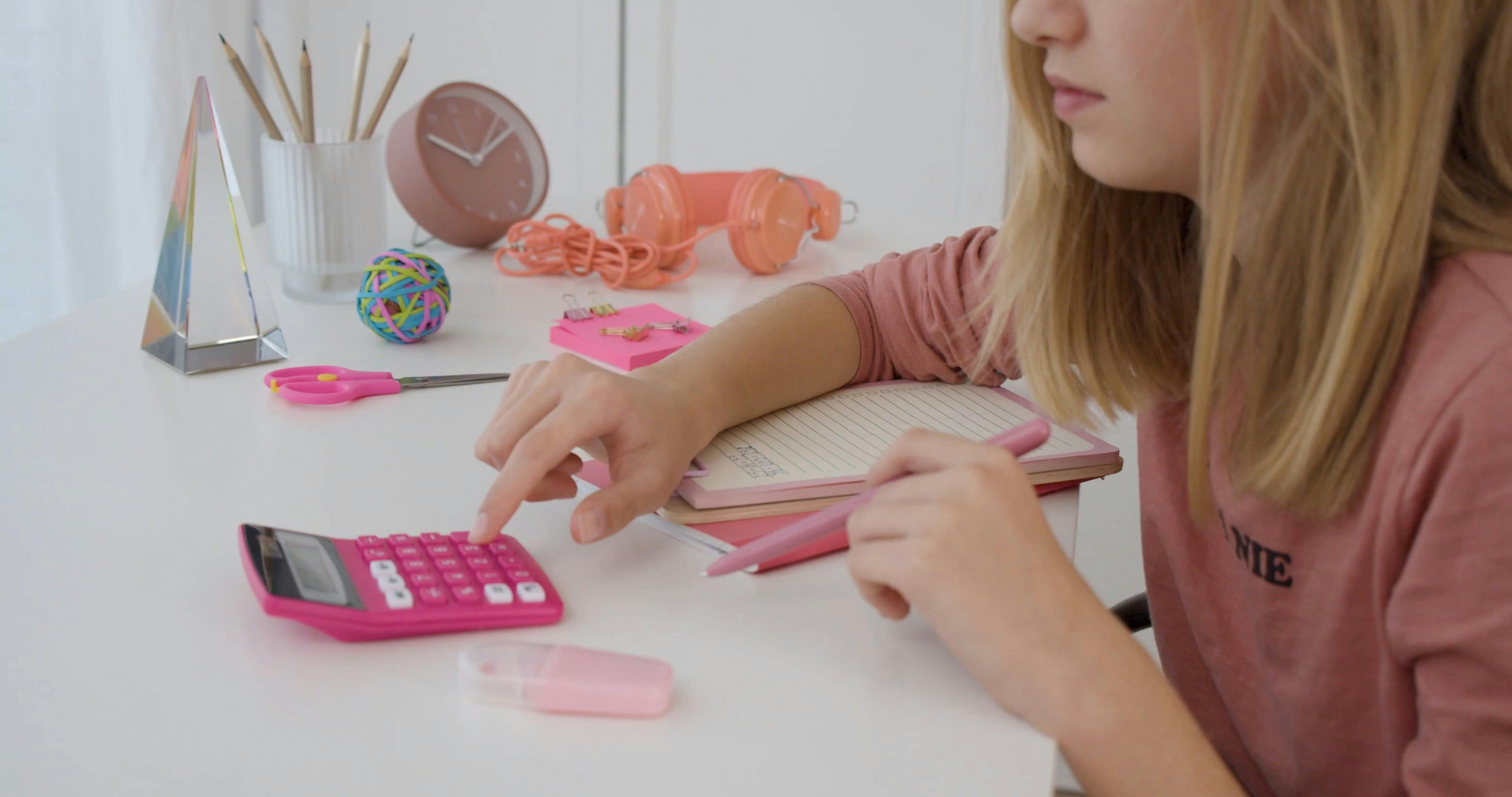 Teenage Girl Using Calculator and Taking Notes · Free Stock Video