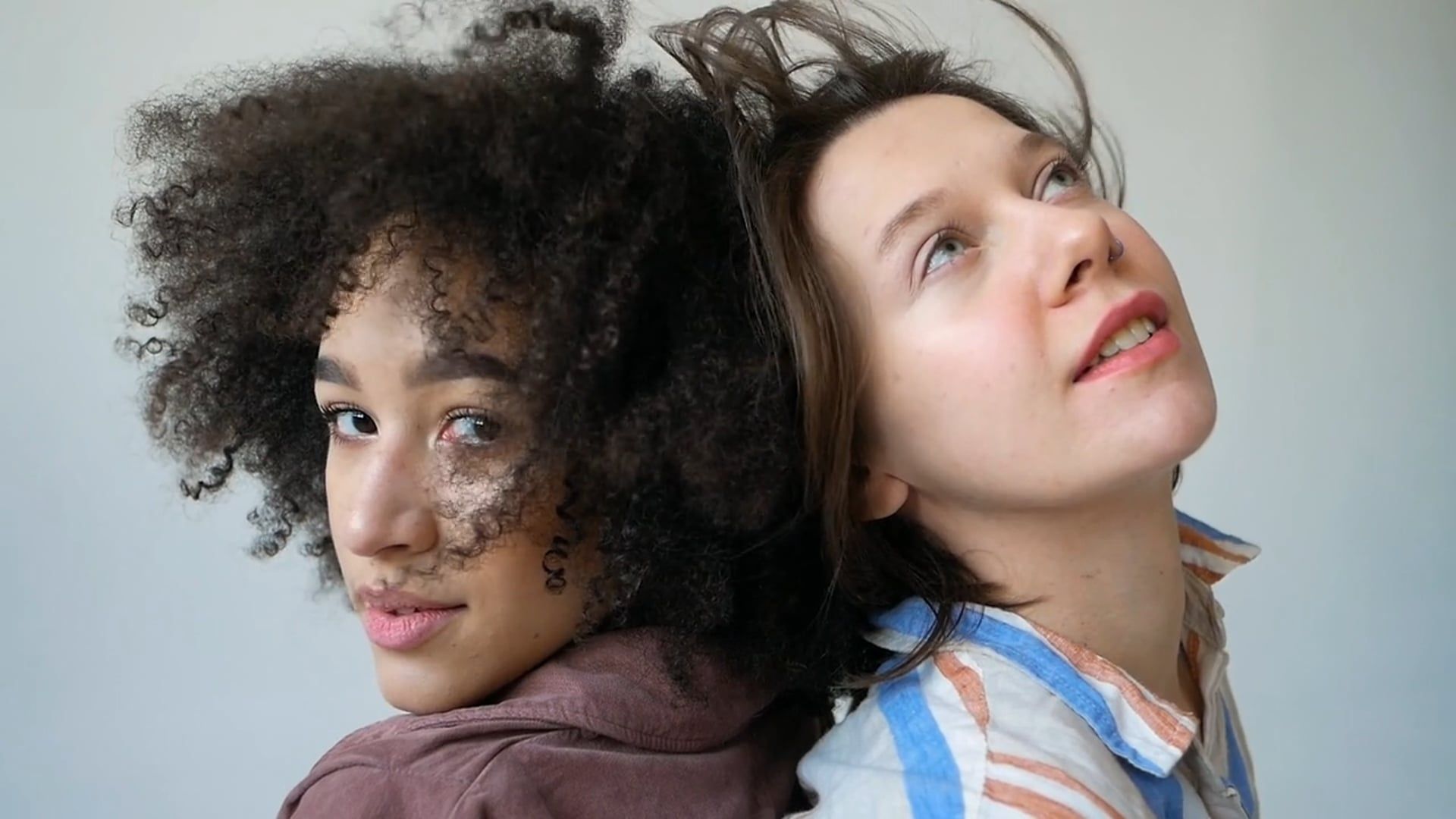 Young Women Posing Back to Back Looking at Camera · Free Stock Video