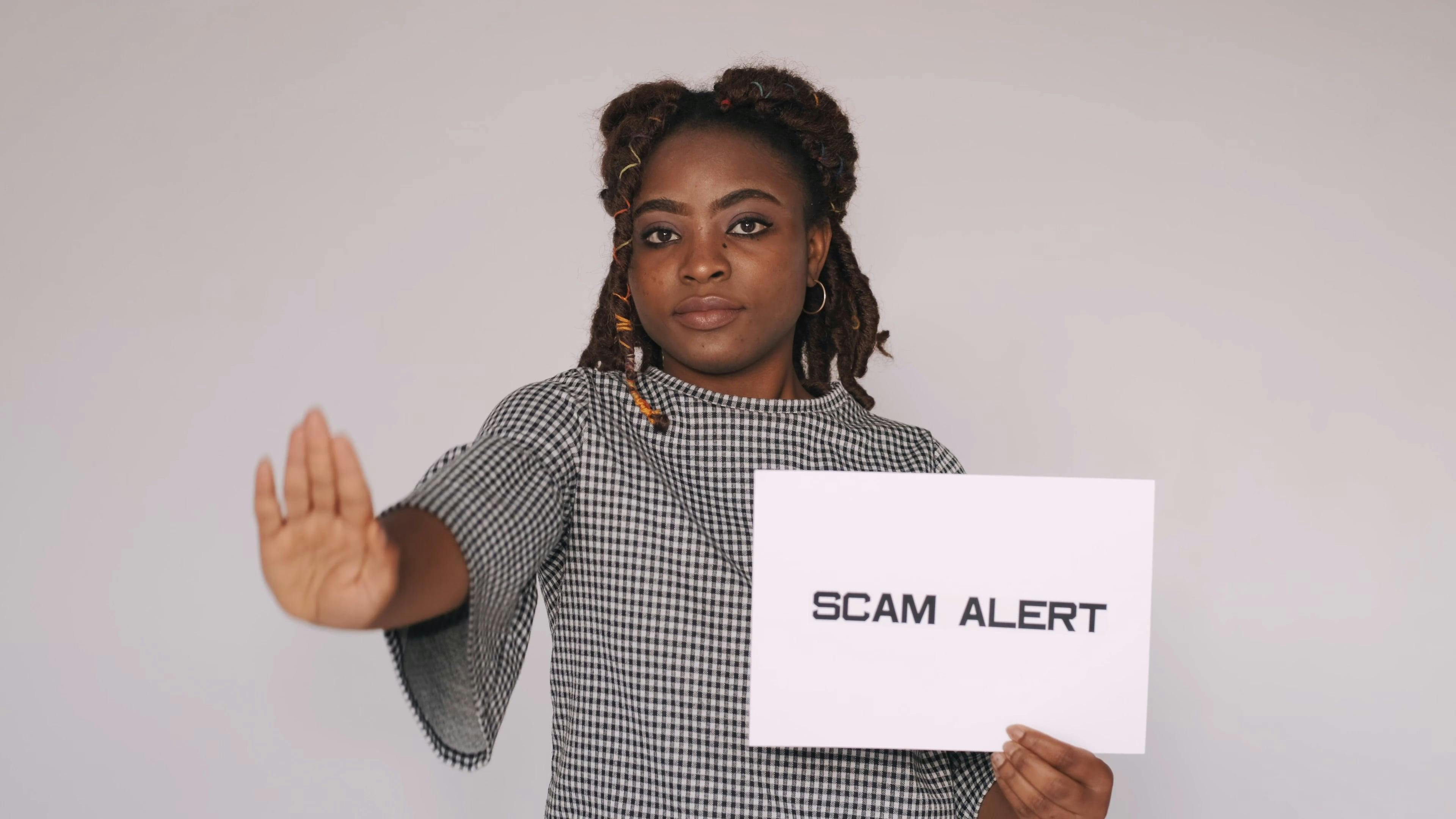 Woman Holding a Scam Alert Sign Free Stock Video Footage, Royalty-Free ...