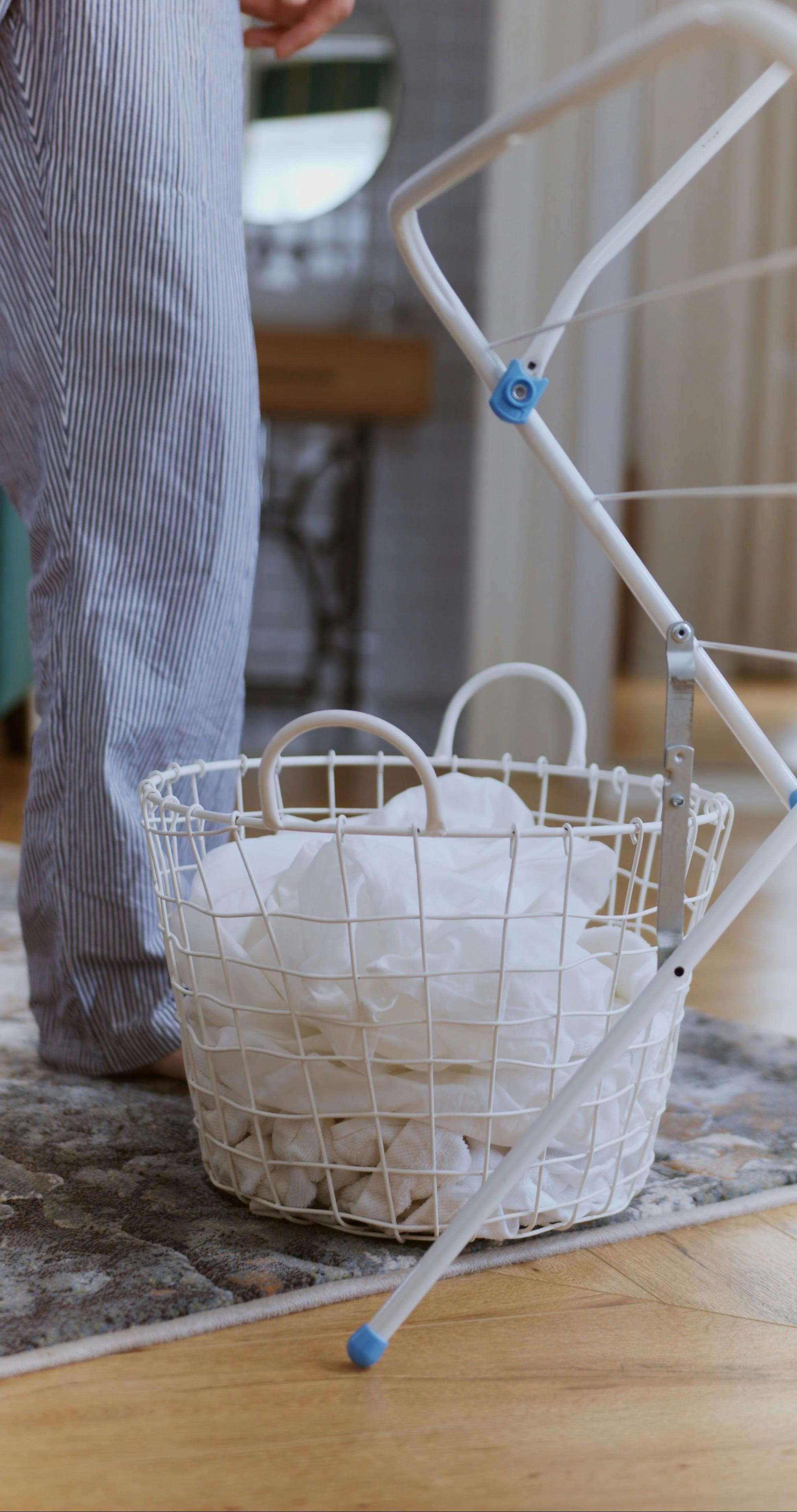 Woman Putting Clothes on a Clothing Rack · Free Stock Video