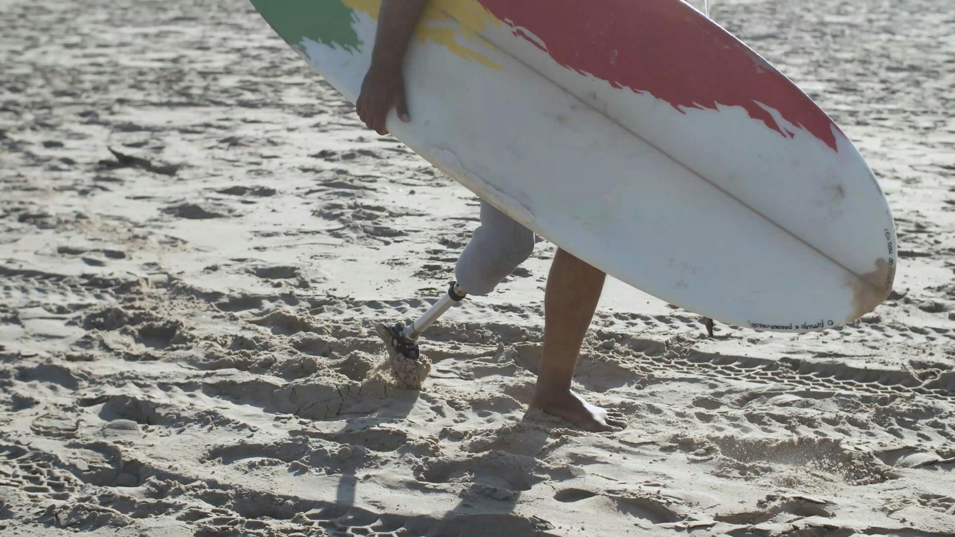 A Man Walking on the Seashore While Holding a Surf Board Free Stock ...