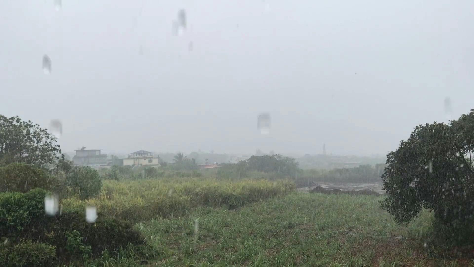 Slow motion Shot of Rain Pouring into a Water Ponding · Free Stock Video