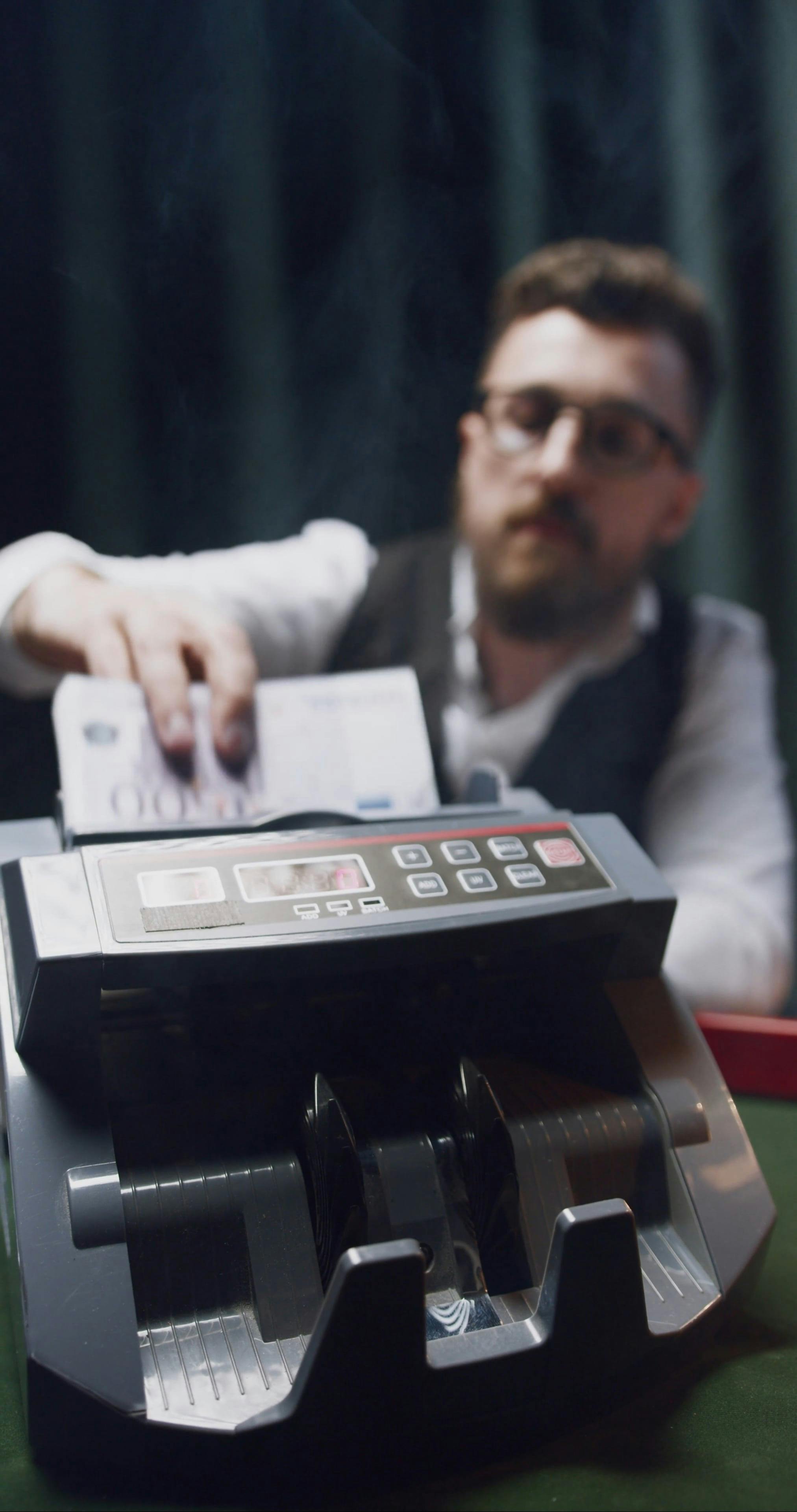 A Guy Counting Money in a Bill Counter Free Stock Video Footage ...