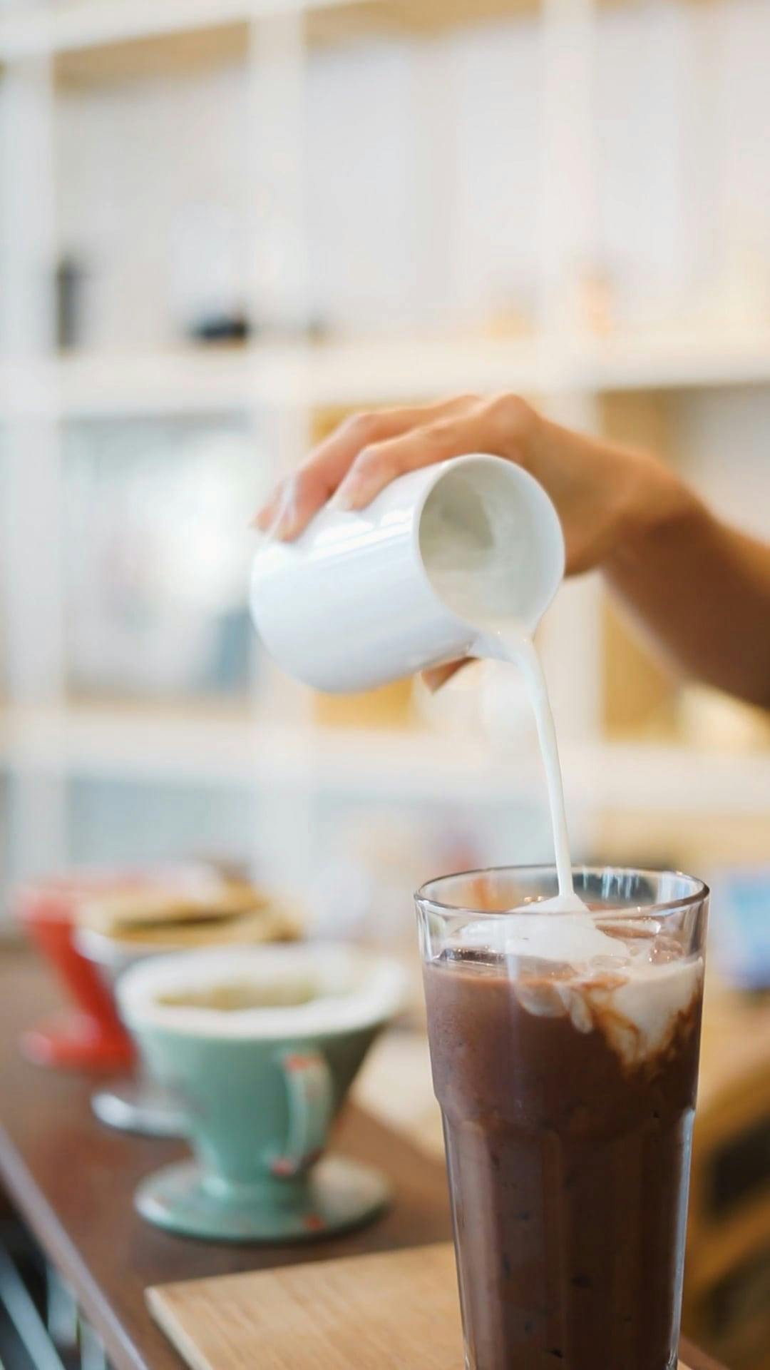 Pouring Milk on a Cup of Cold Chocolate · Free Stock Video
