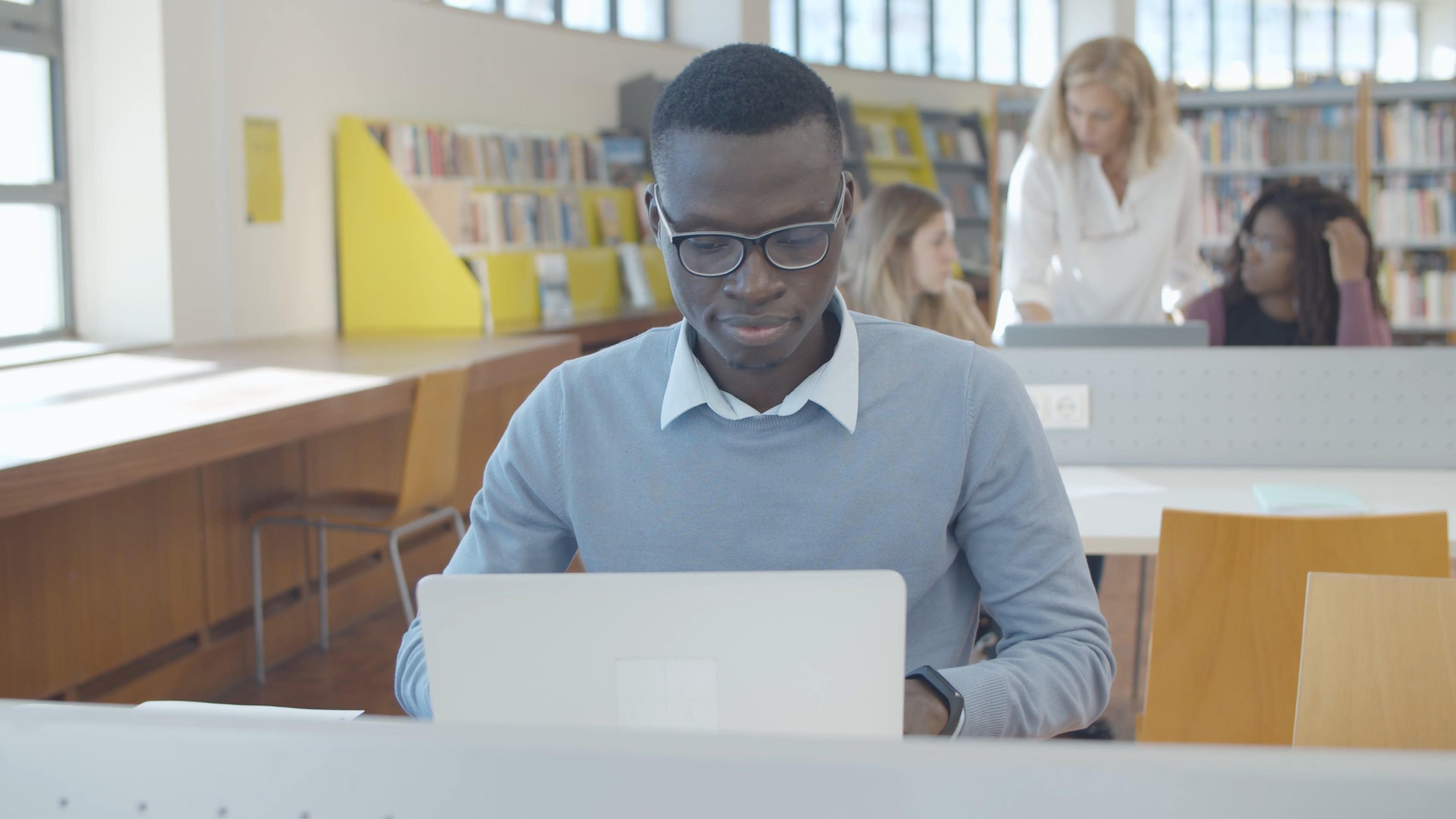 Man Using a Laptop in a Library · Free Stock Video