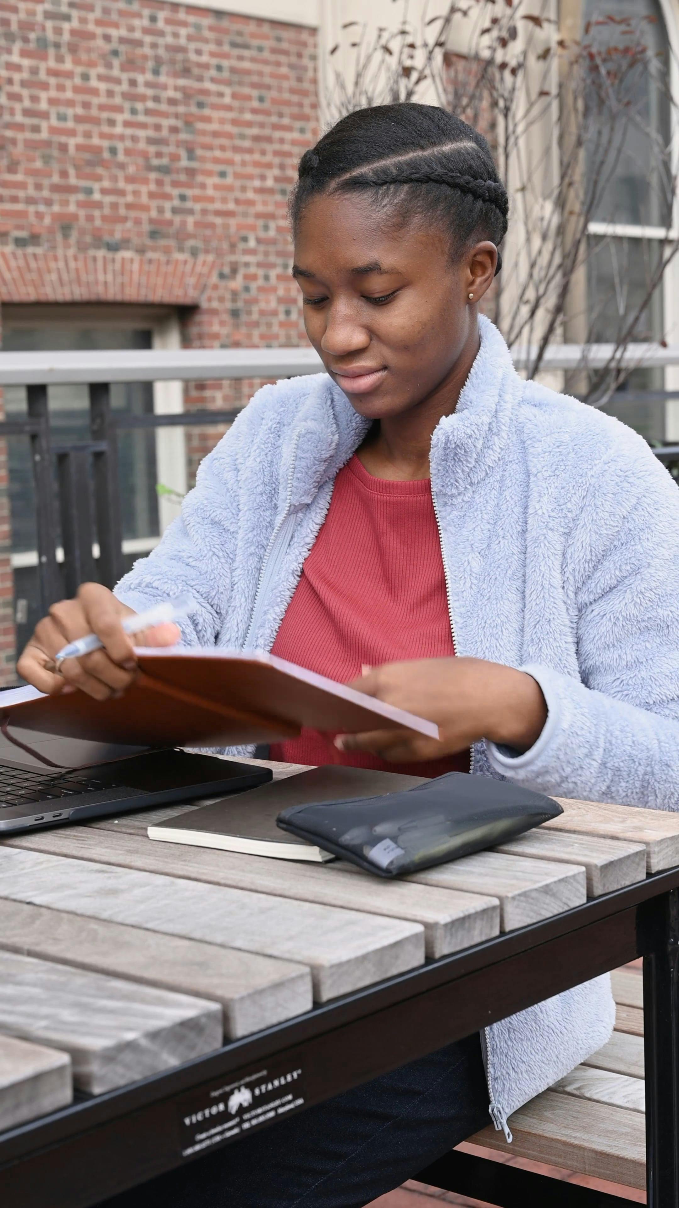 A Woman Writing on a Notebook · Free Stock Video