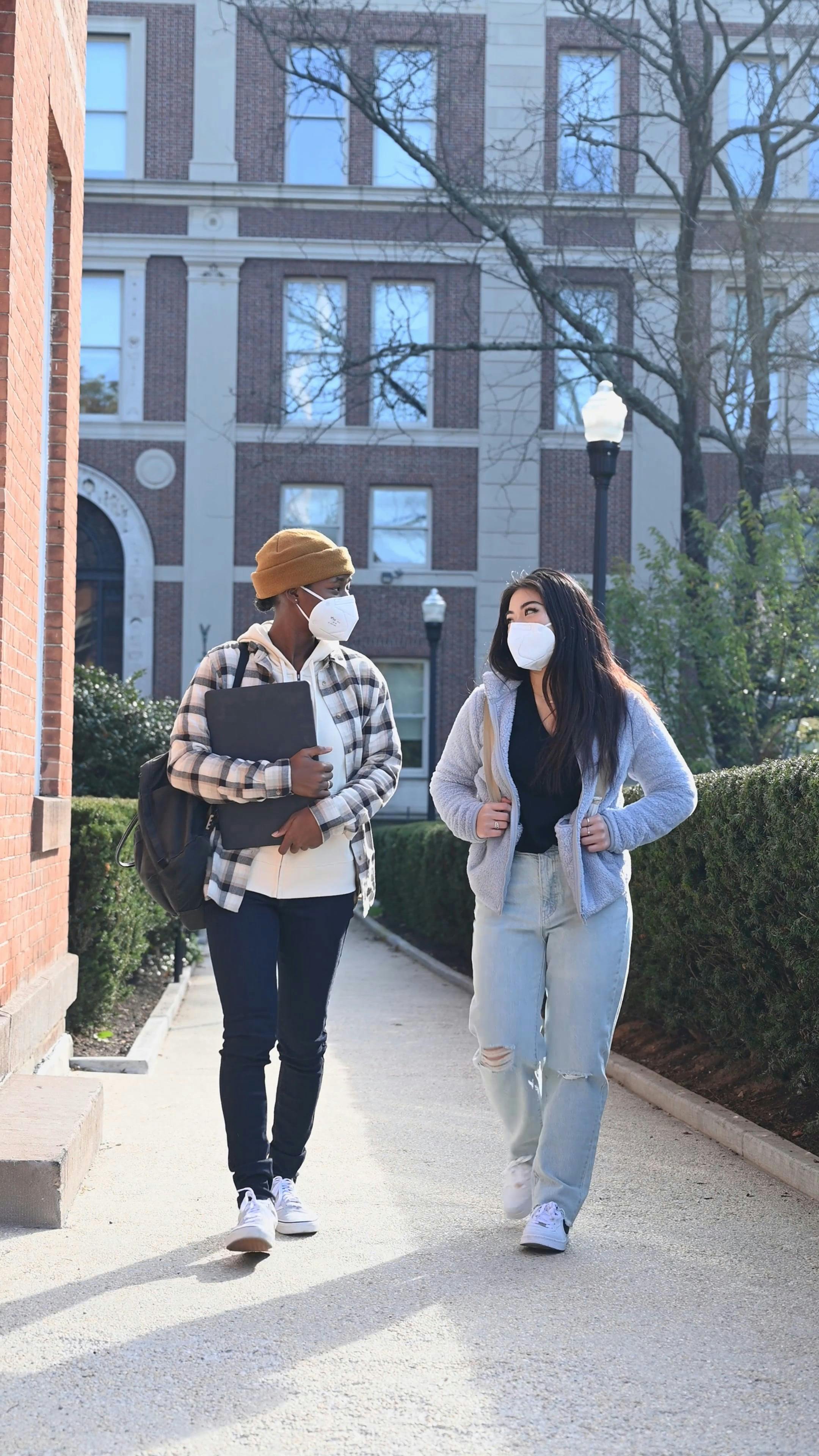 Two Young People Wearing Face Masks and Walking · Free Stock Video