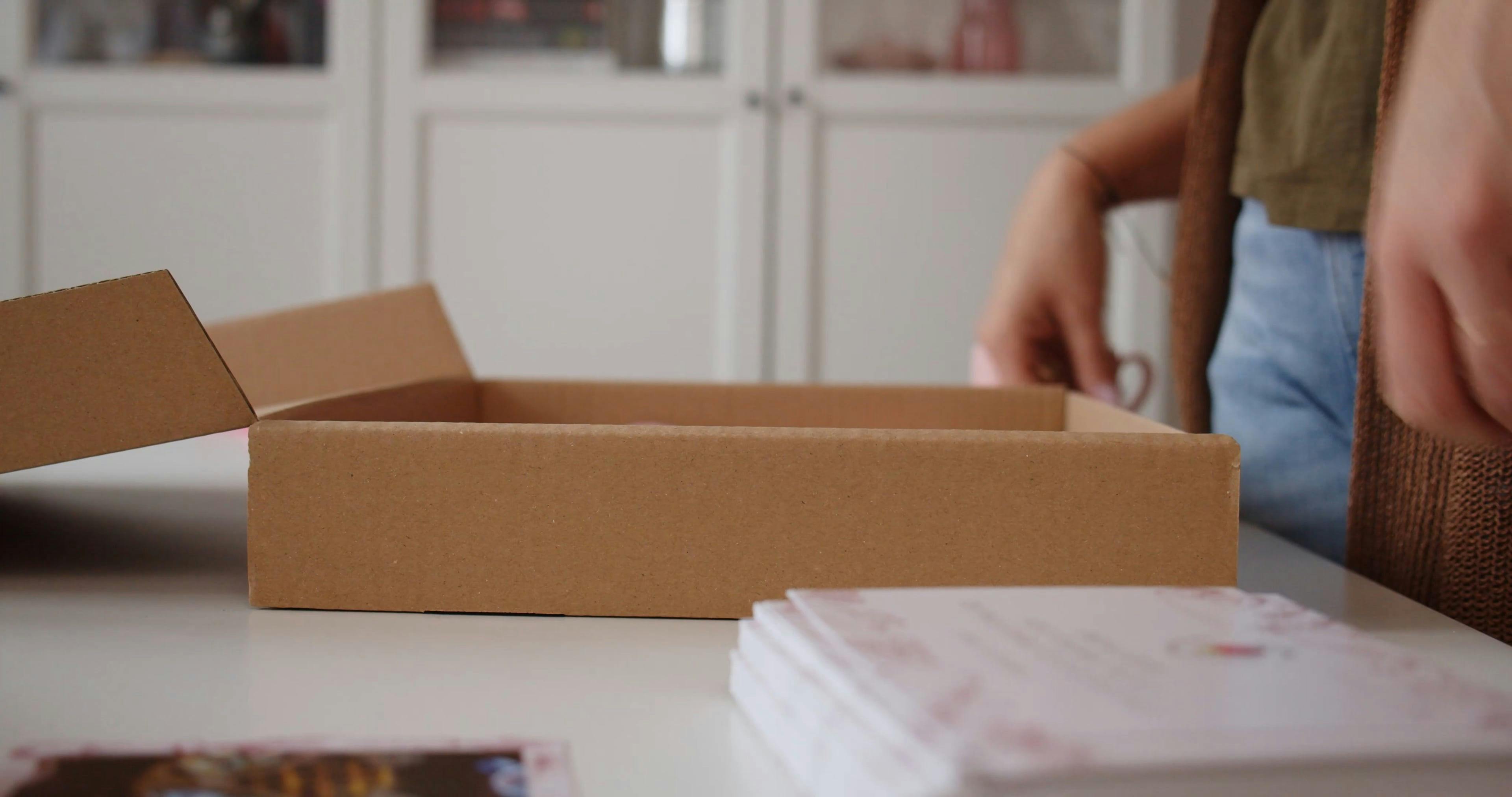 A Person Closing a Box on Top of a Table Free Stock Video Footage ...