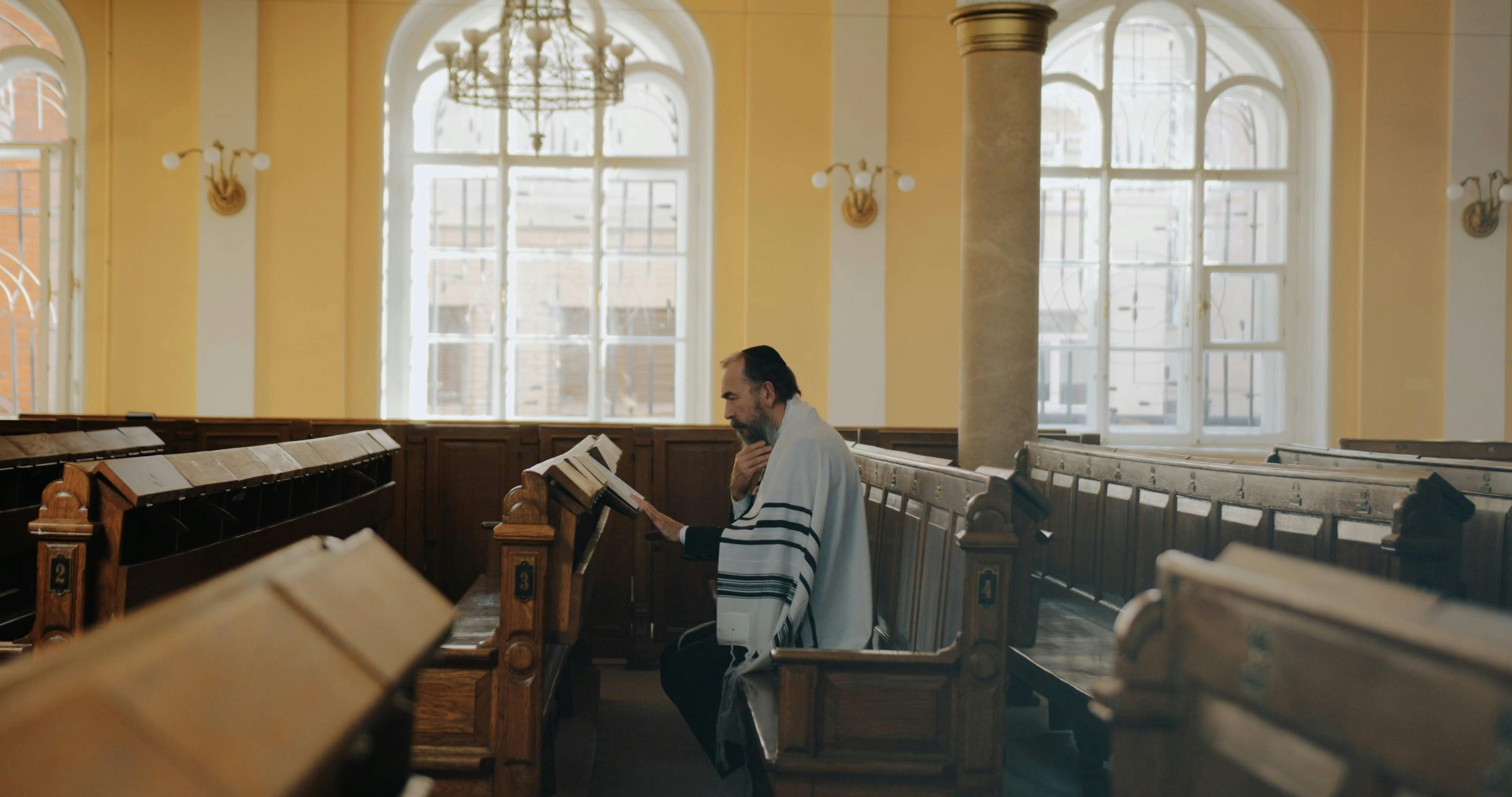 A Man Sitting Inside a Church While Reading a Bible · Free Stock Video