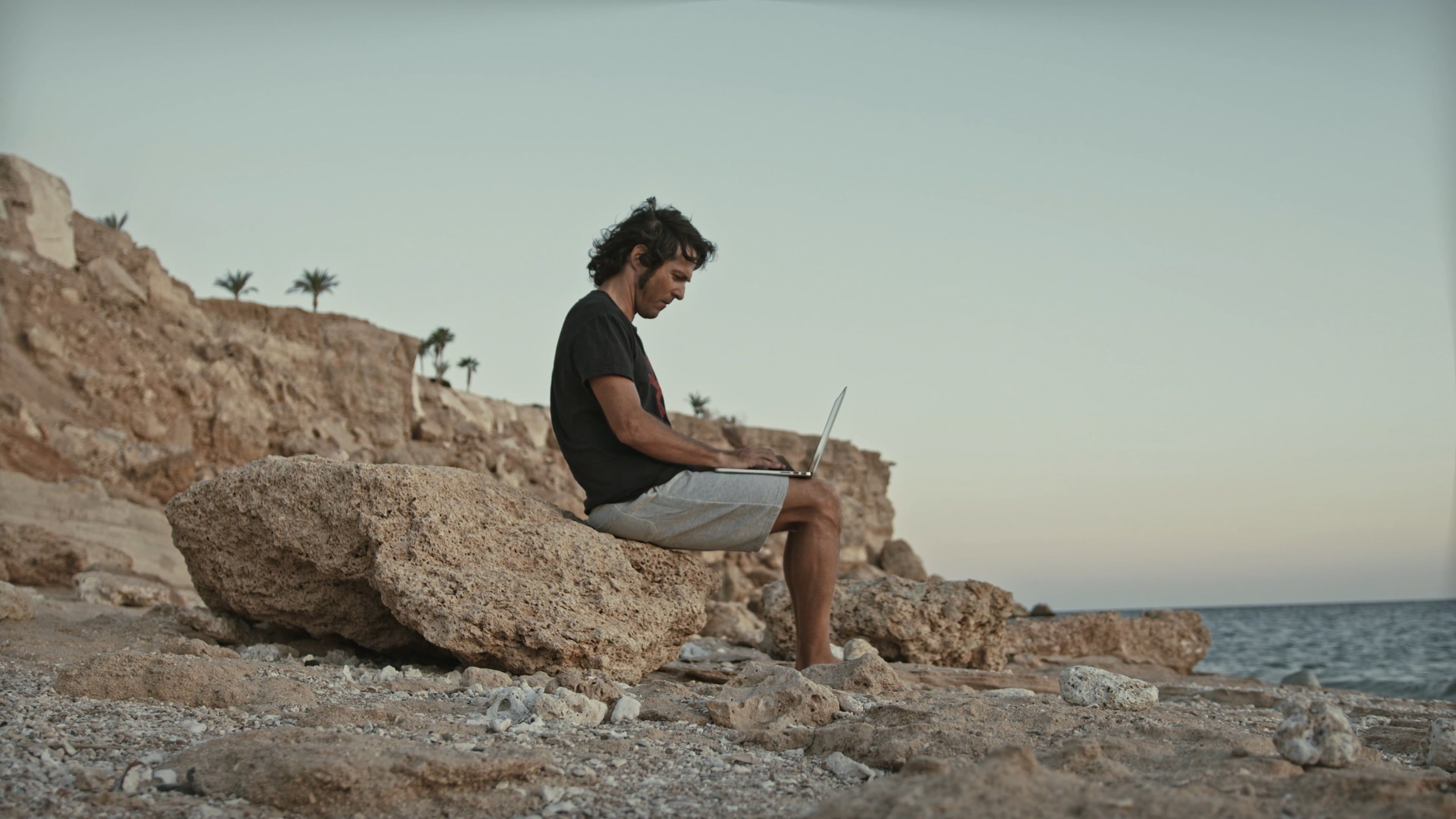 A Man Using A Laptop On The Beach Free Stock Video Footage, Royalty ...
