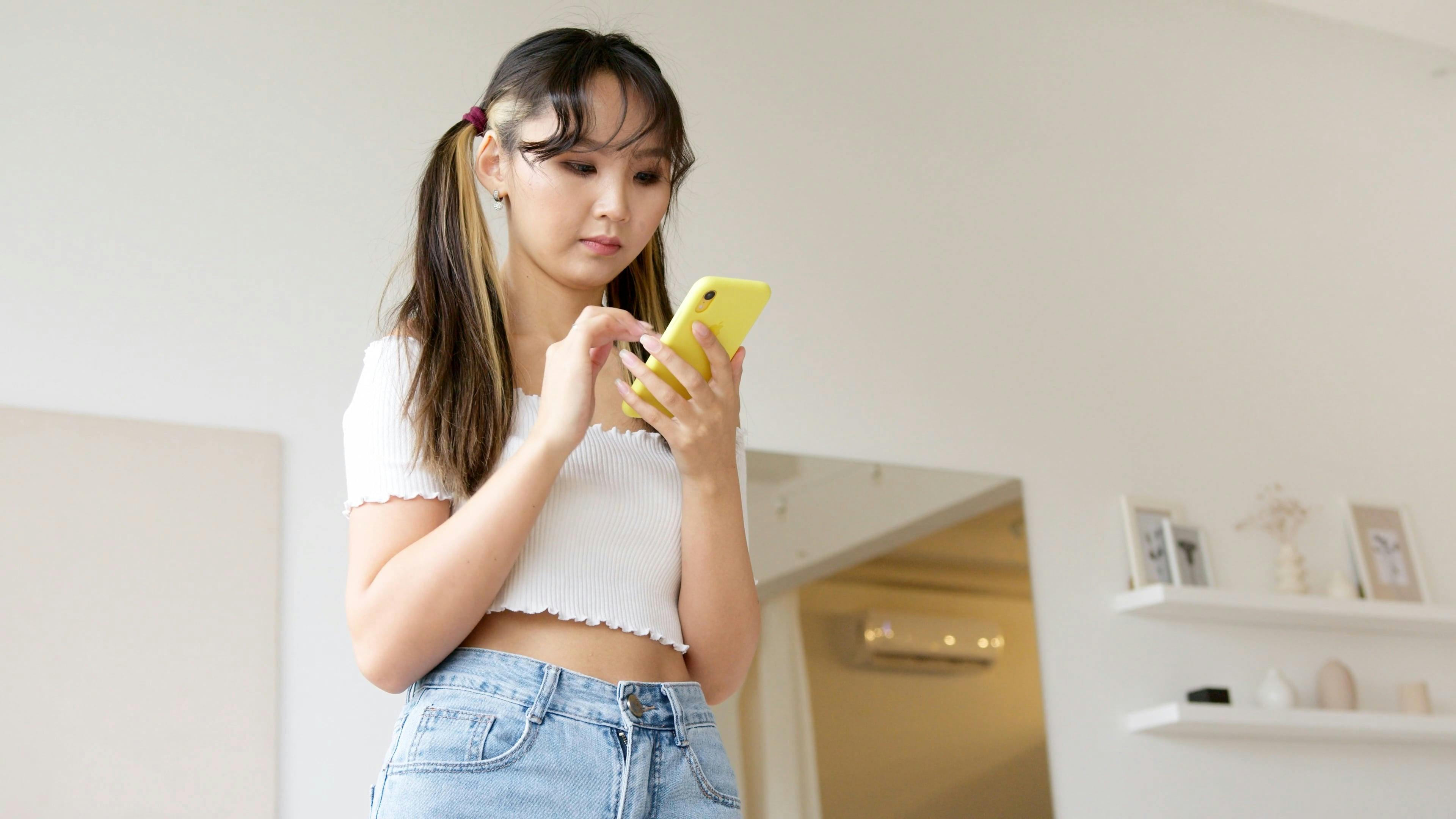 A Girl Dancing while Using Her Smartphone · Free Stock Video