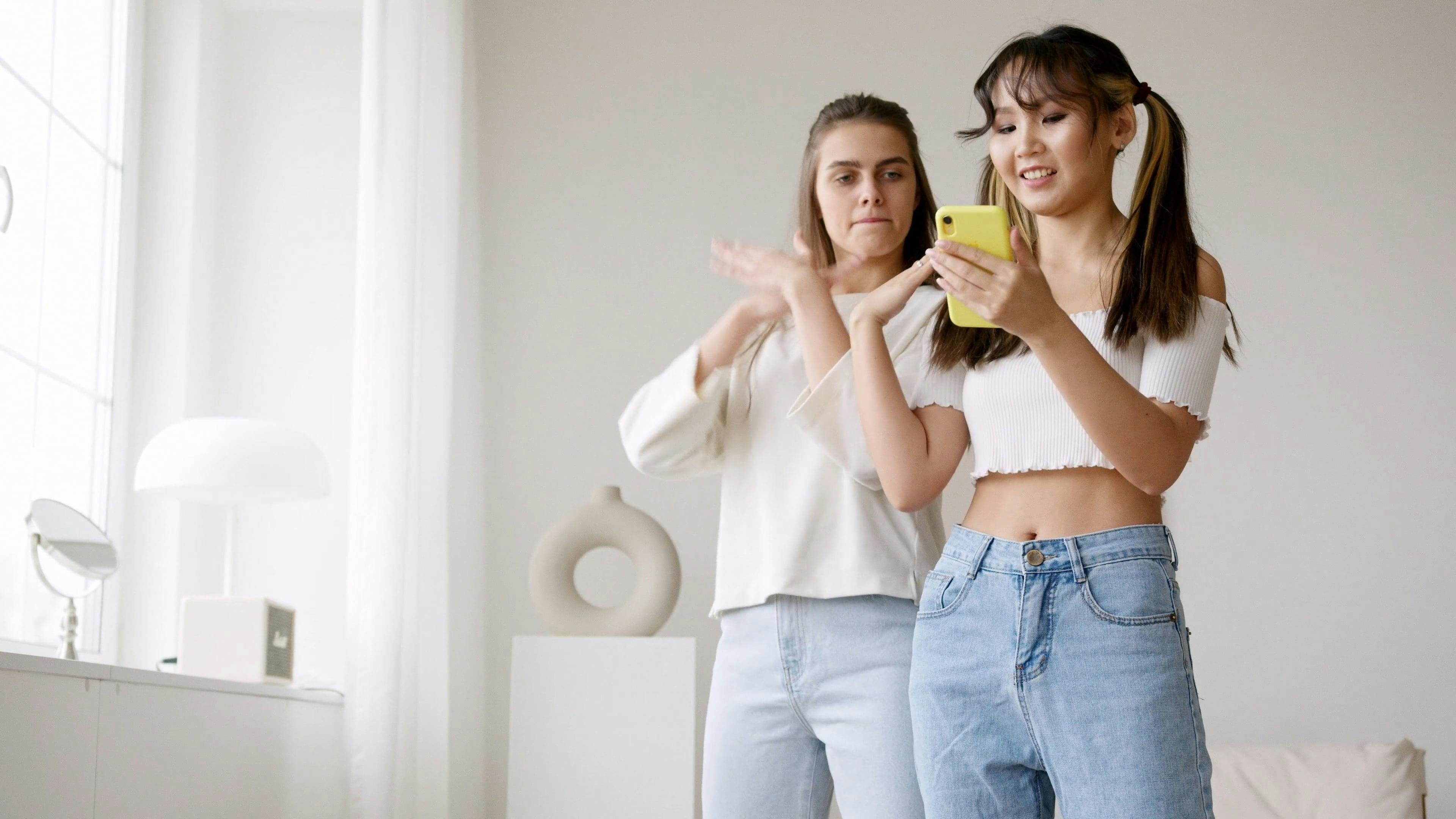 Girls Dancing while Using Smartphone · Free Stock Video