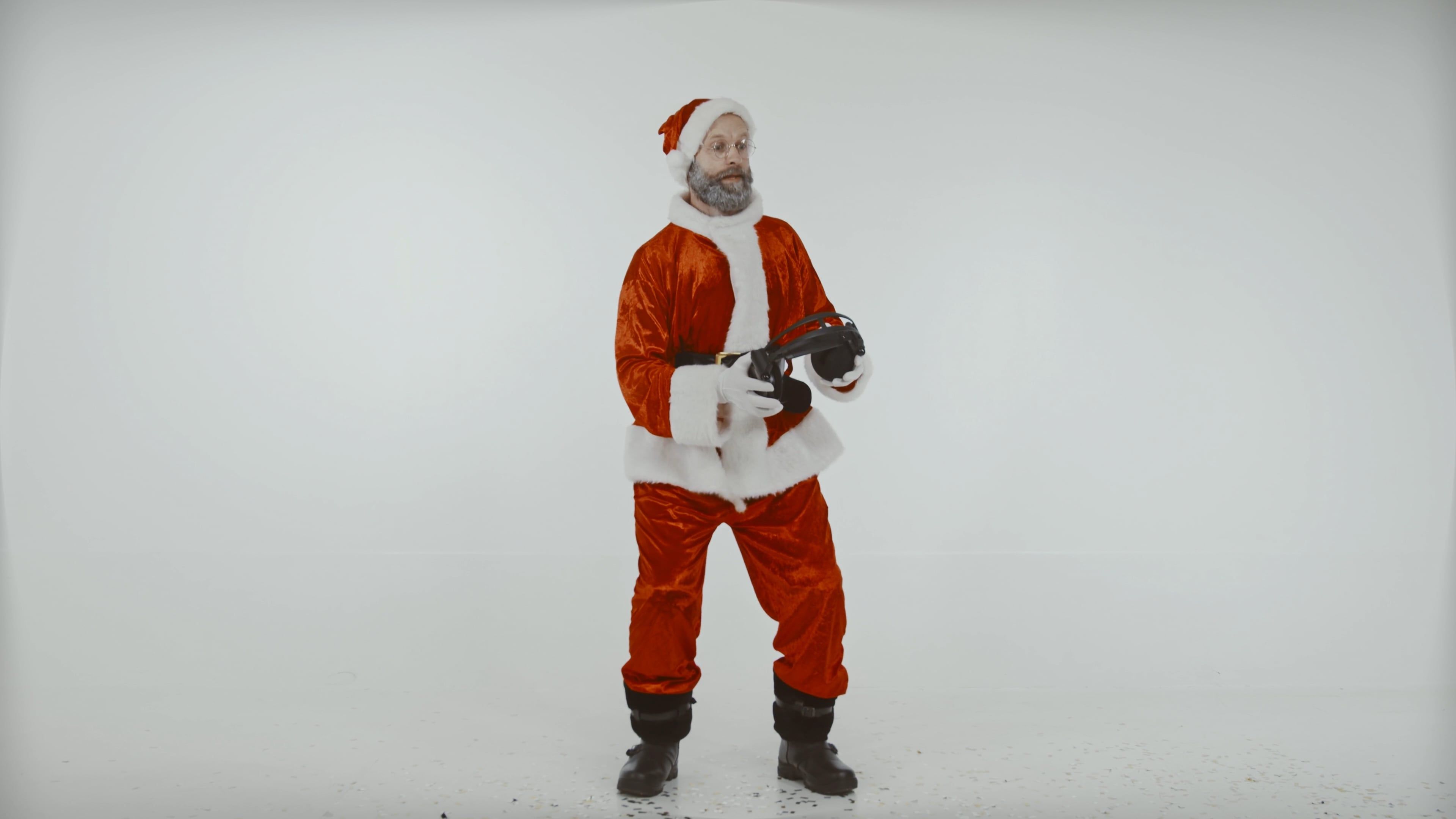Man in Santa Claus Costume Dancing with Headphones · Free Stock Video