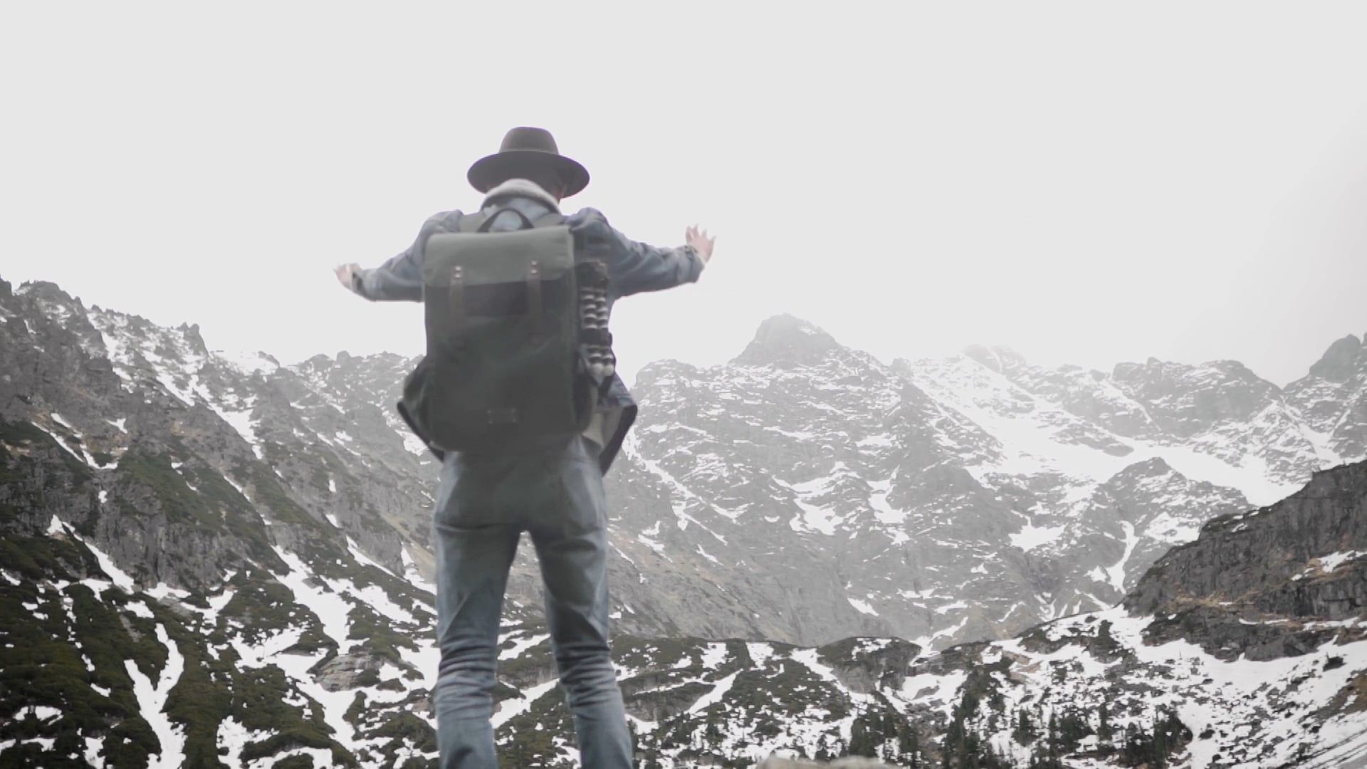 Man Standing on a Rock Facing Snow Capped Mountains Free Stock Video ...