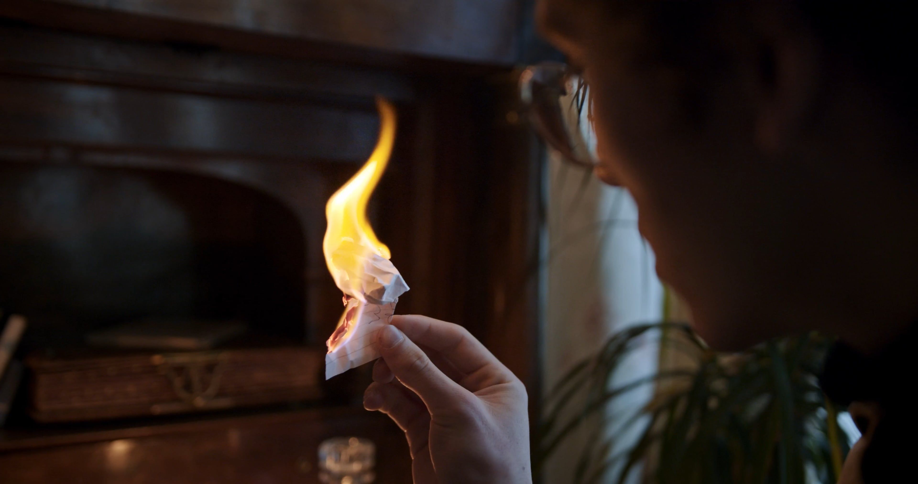 A Person Holding a Piece of Crumpled Burning Paper · Free Stock Video