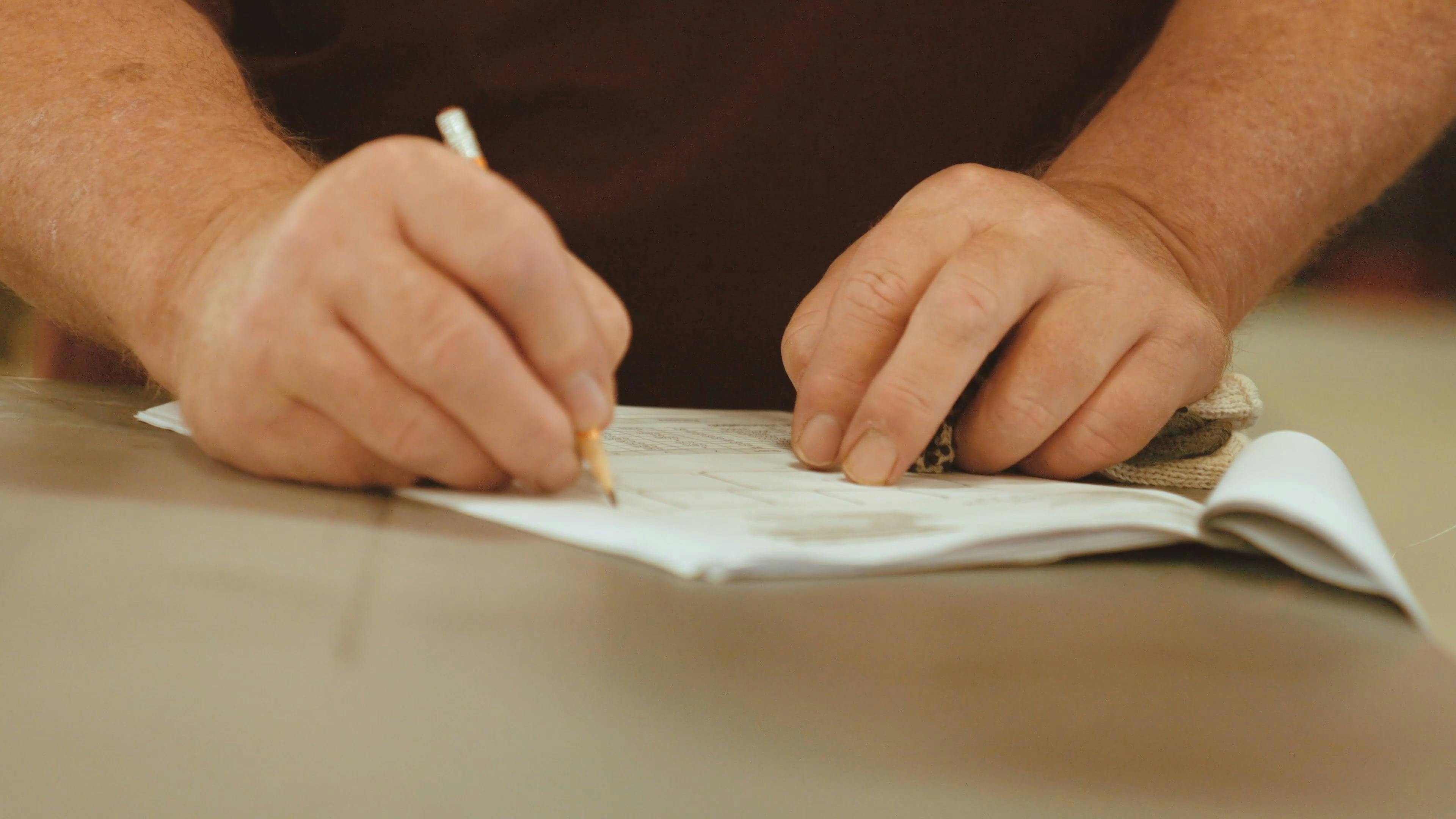 Writing And Erasing On A Sheet Of Paper · Free Stock Video