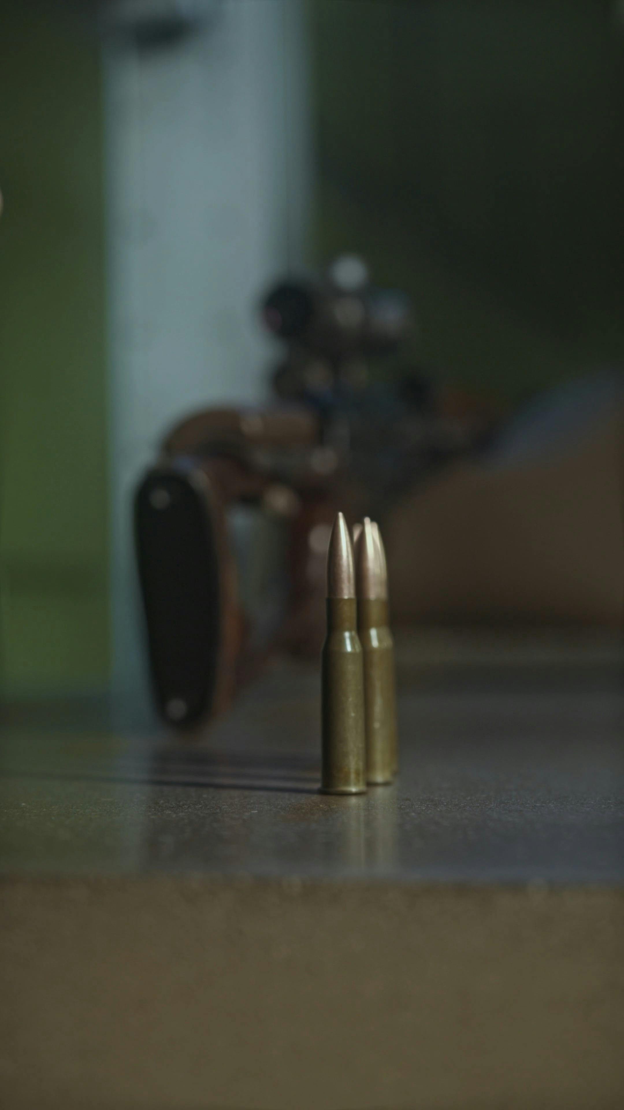 Close-Up Video of Hands Picking Up Bullet Shells · Free Stock Video