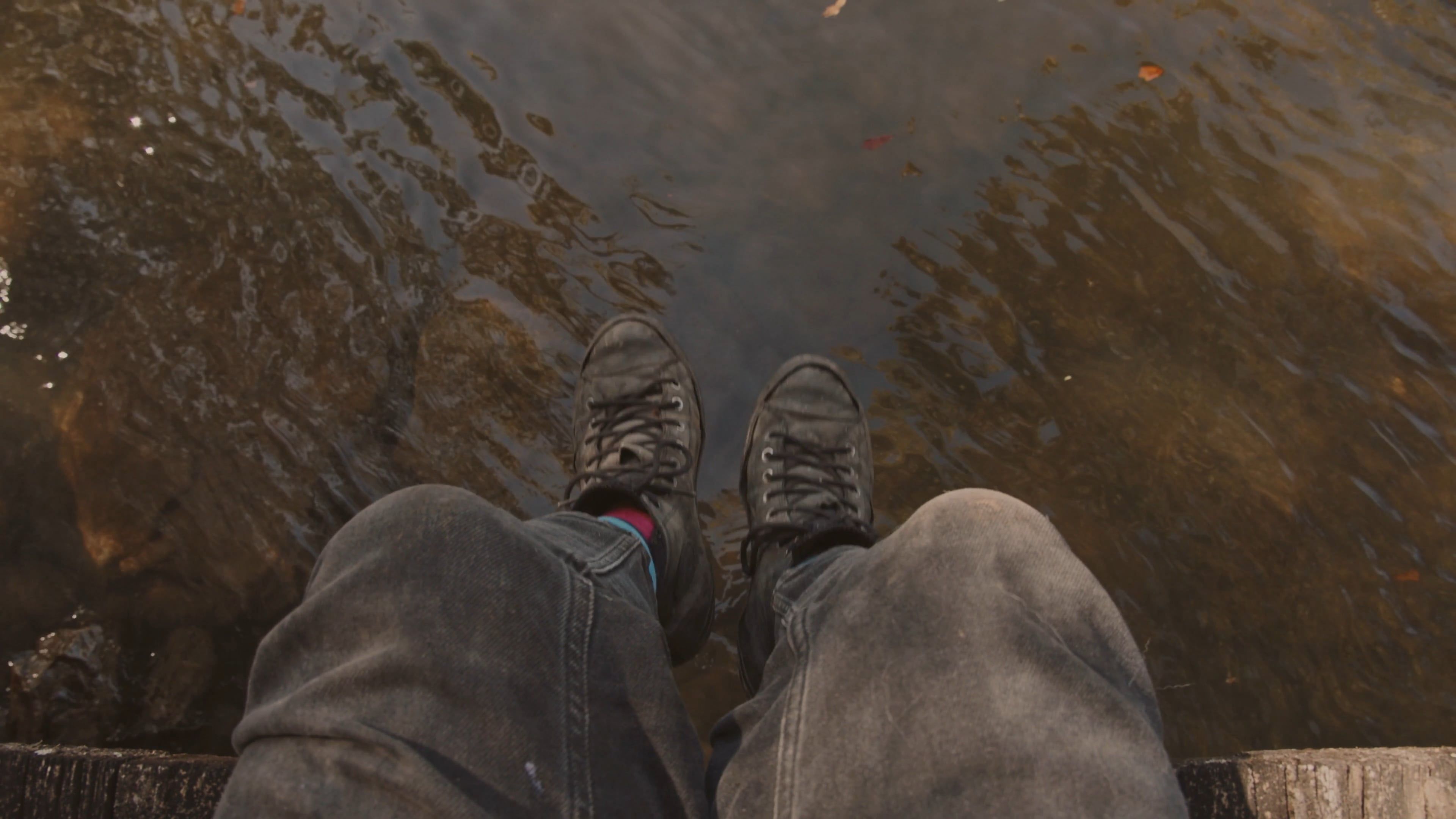 A Pair of Feet Wagging Above a River Stream Free Stock Video Footage ...
