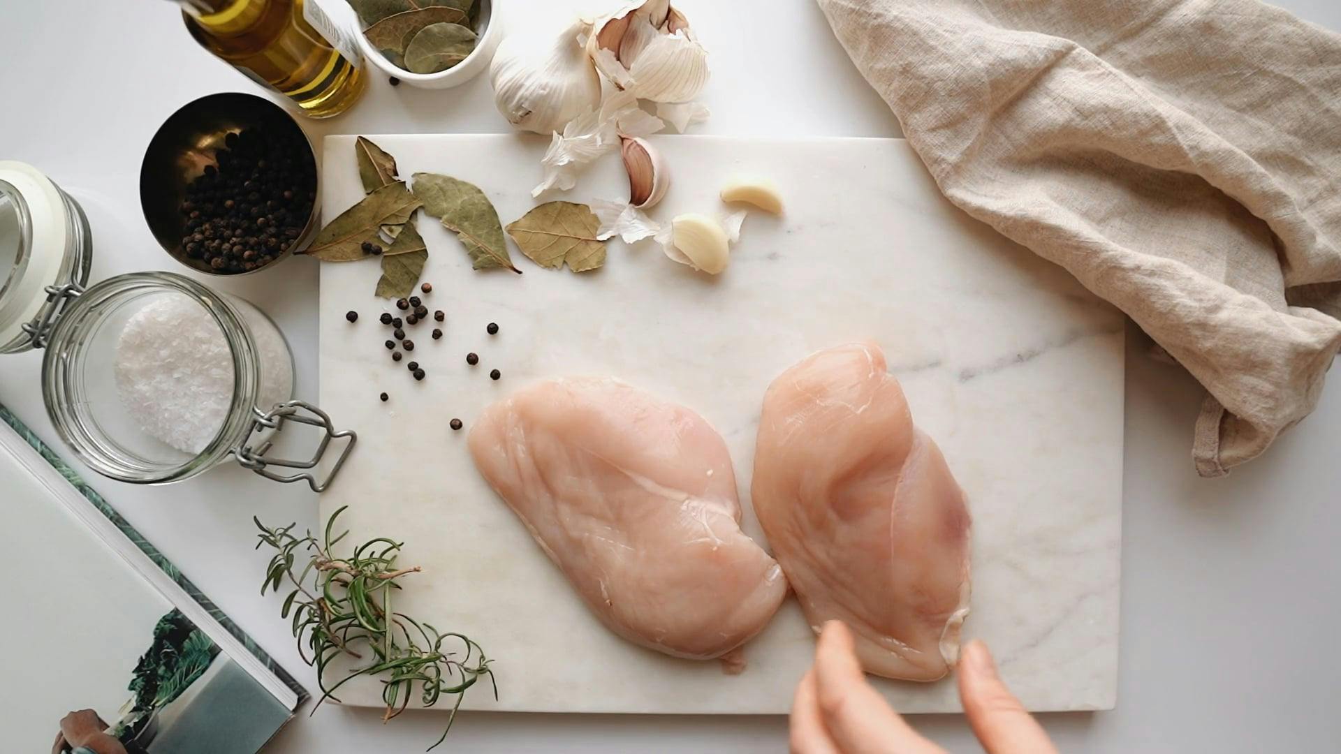 Person Slicing Chicken Meat · Free Stock Video