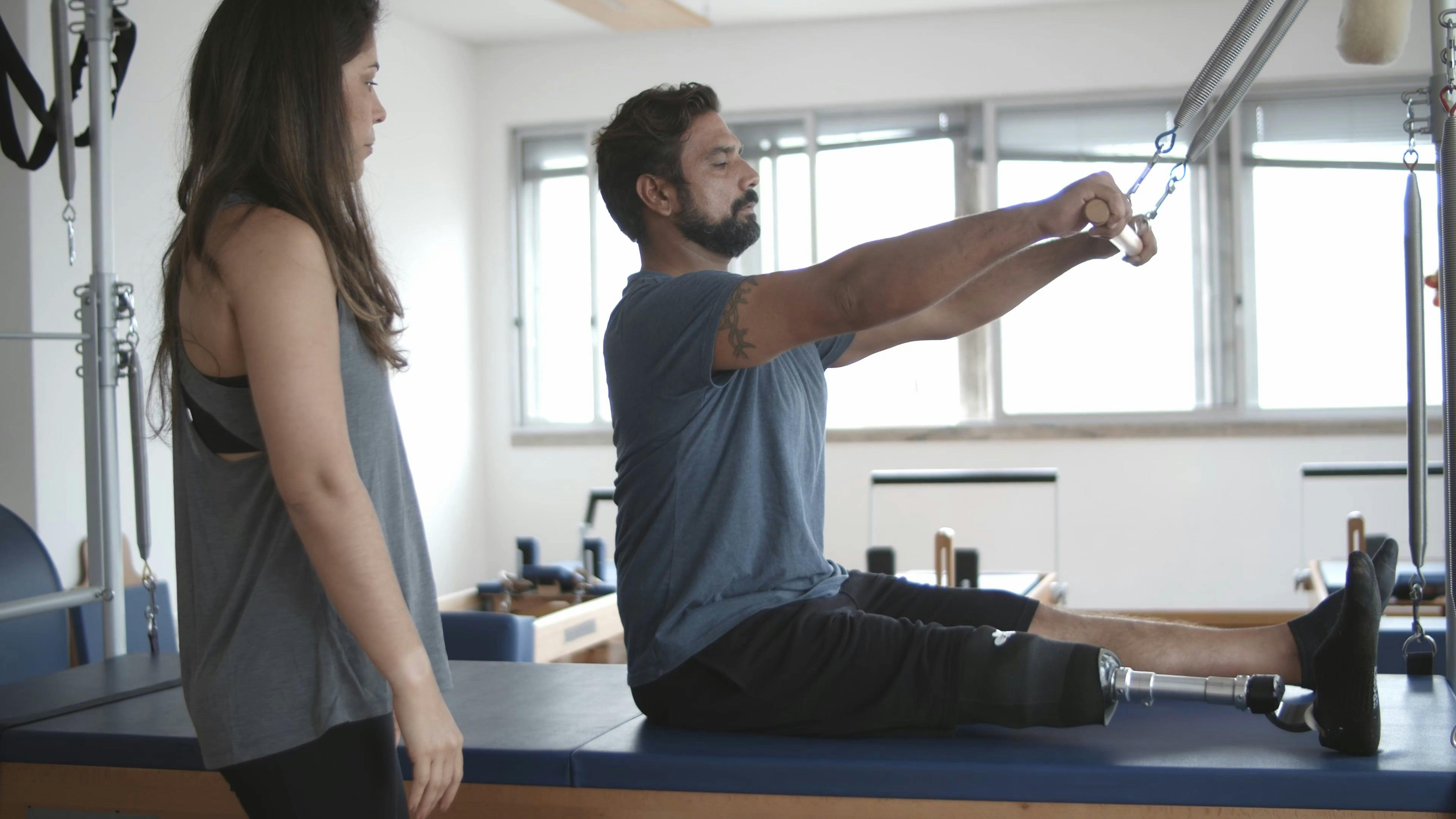 A Woman Helping Exercise a Disabled Man · Free Stock Video