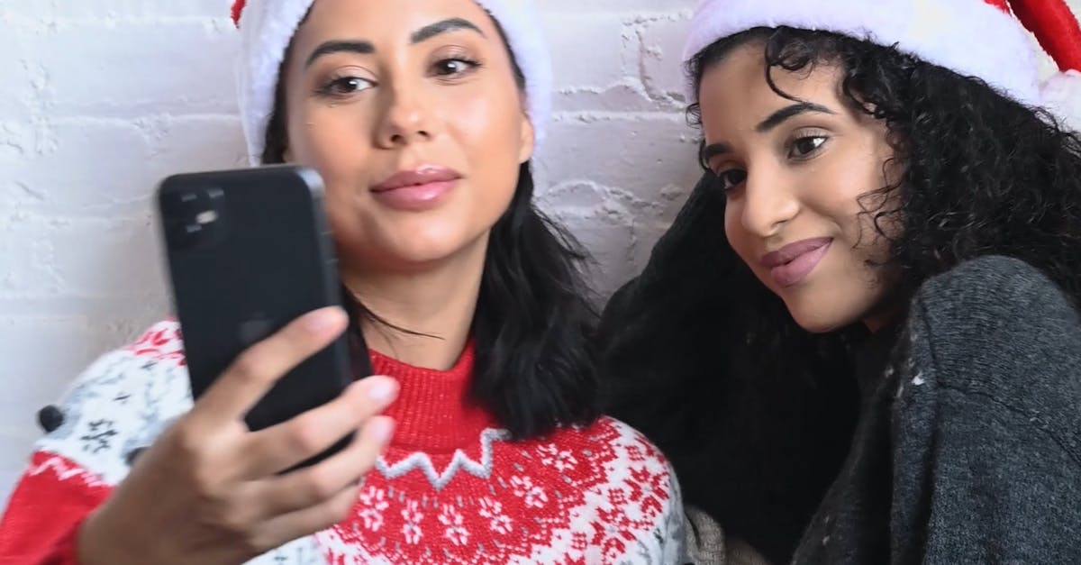 Girls On Christmas Clothes Taking Selfies Together Free Stock Video