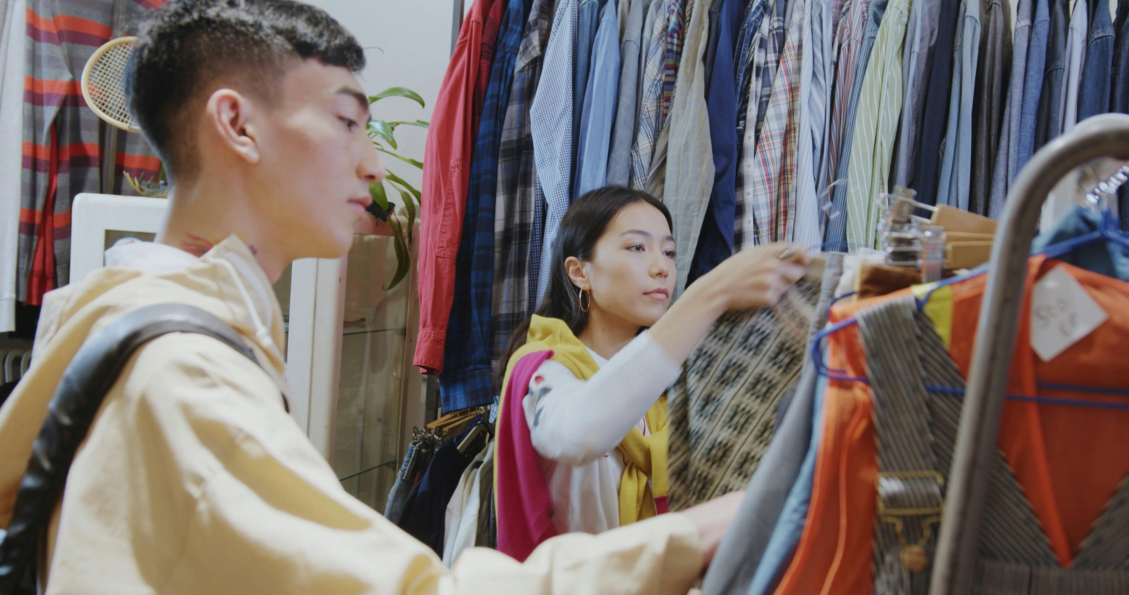 People Looking at the Clothes From a Rack Free Stock Video Footage ...