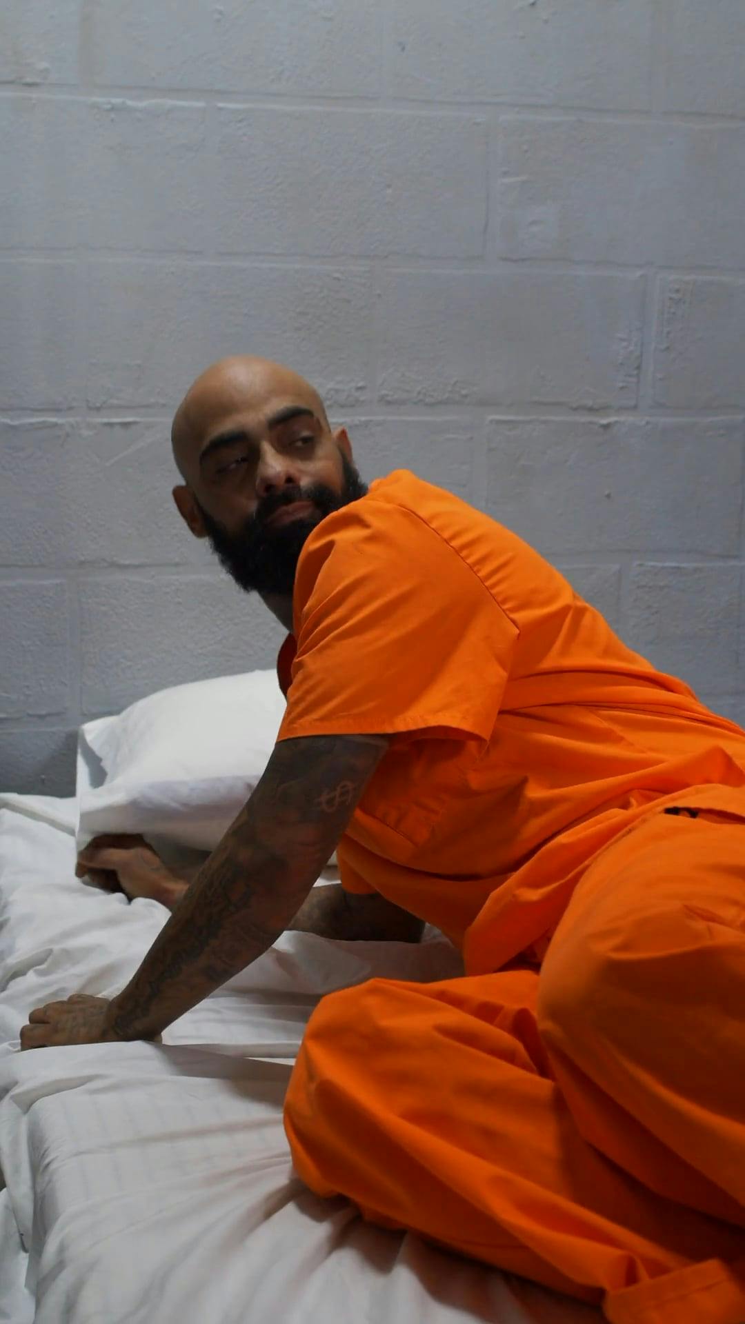 Tattooed Inmate Lying on the Bed Reading a Book · Free Stock Video