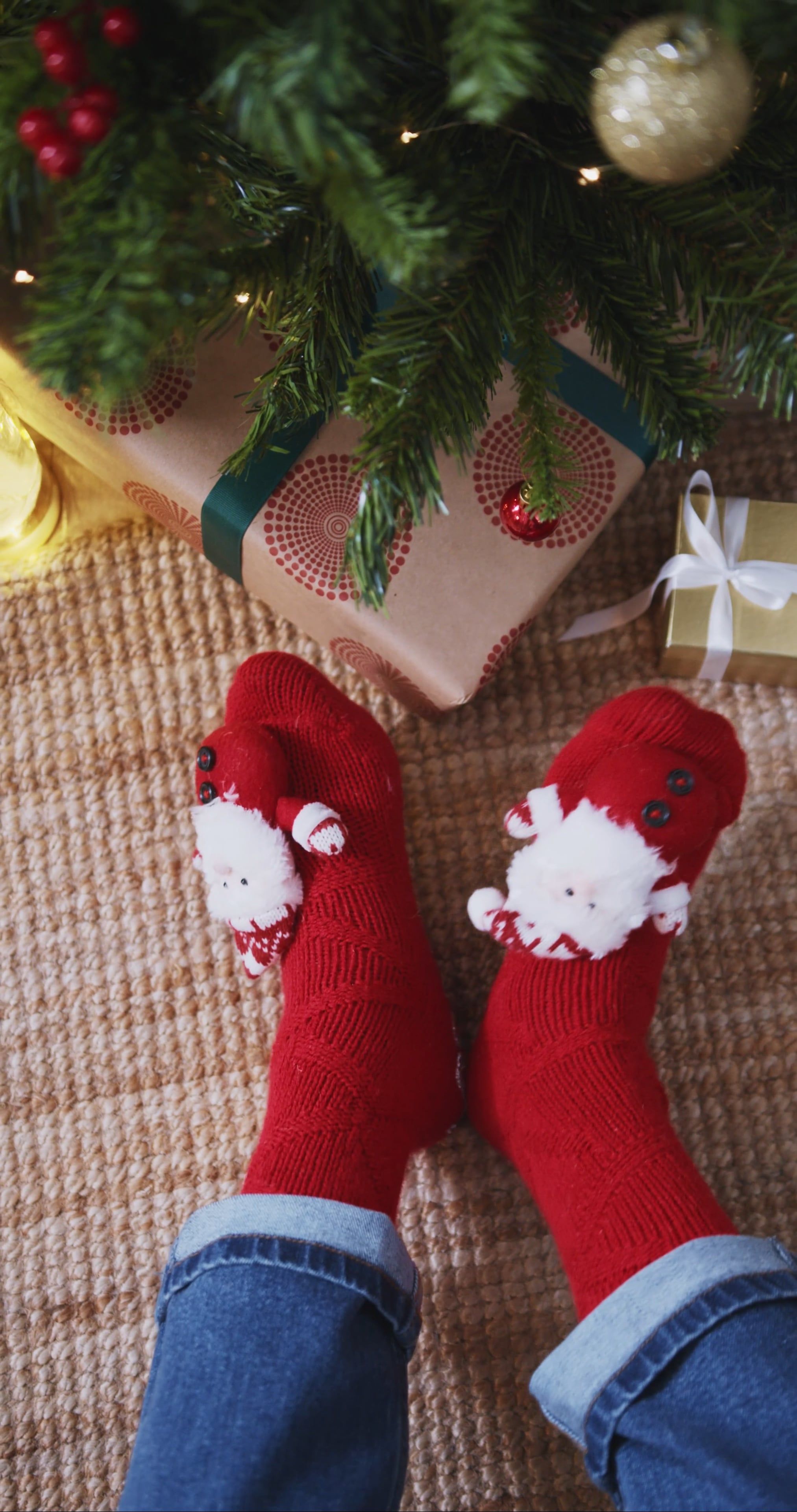 A Person Wearing Red Socks Wiggling His Feet Near Christmas Presents ...