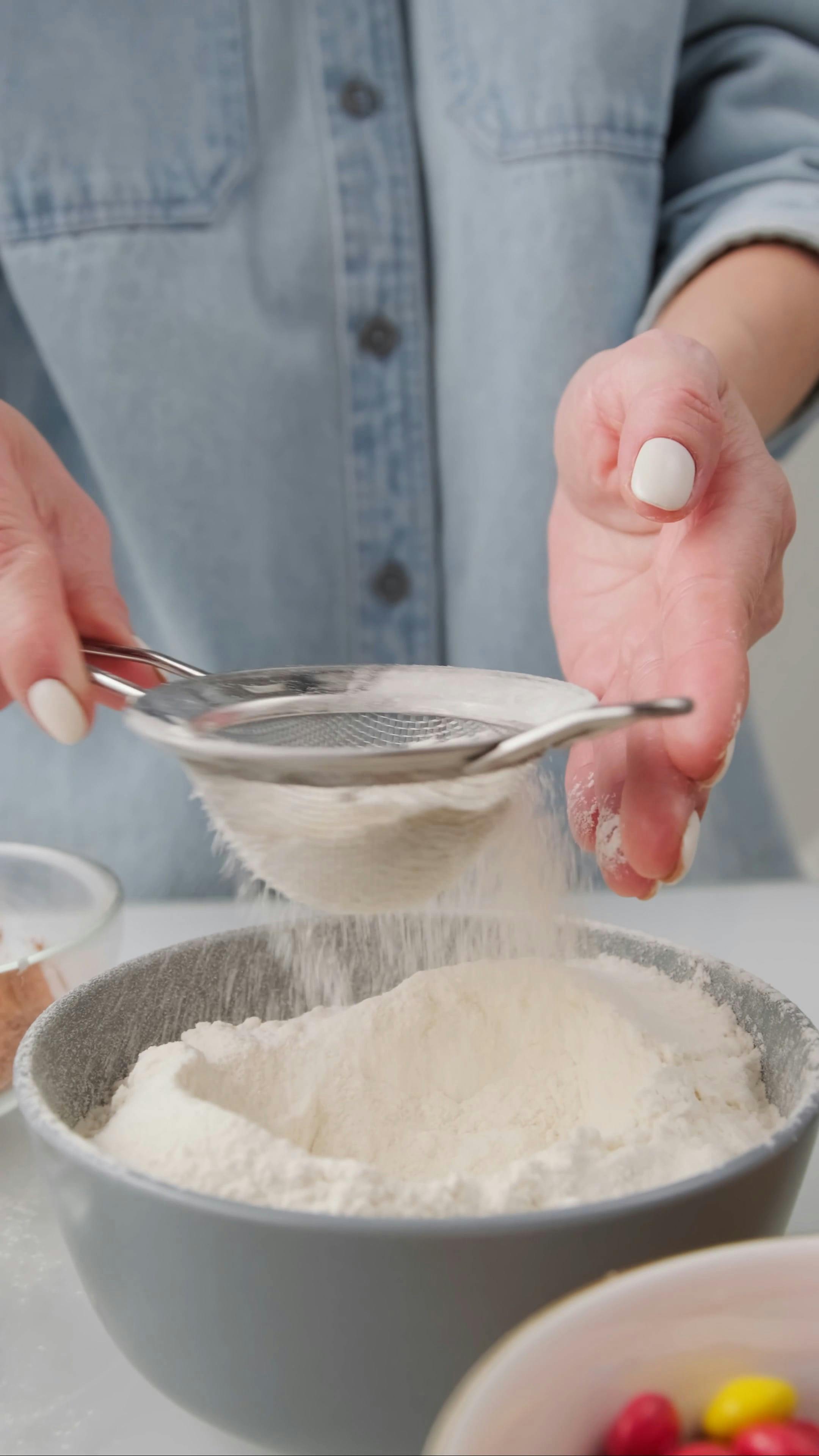 A Person Straining The Flour To Be Used In Baking · Free Stock Video