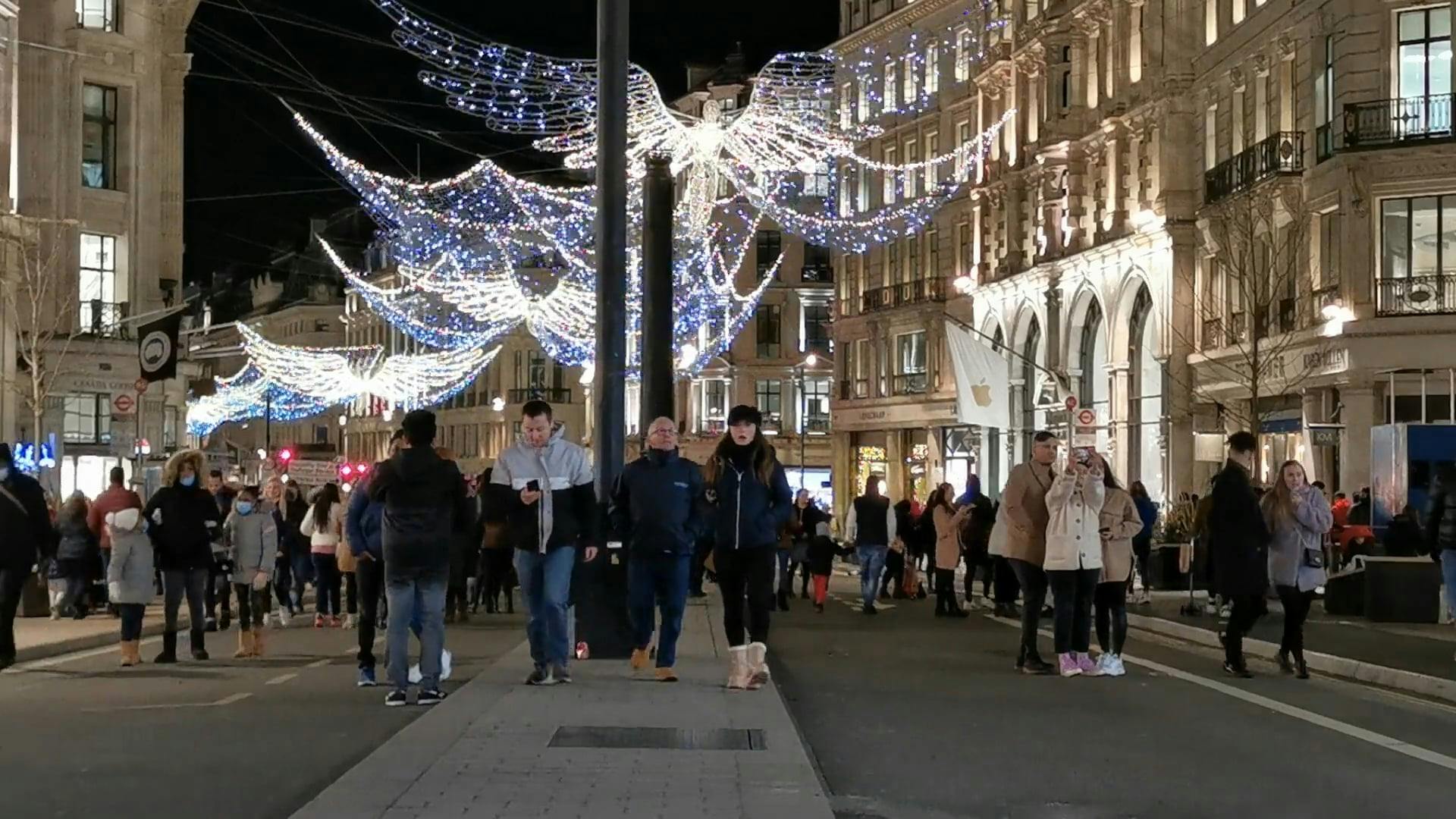 People Walking In Street Decorated With Christmas Lights · Free Stock Video