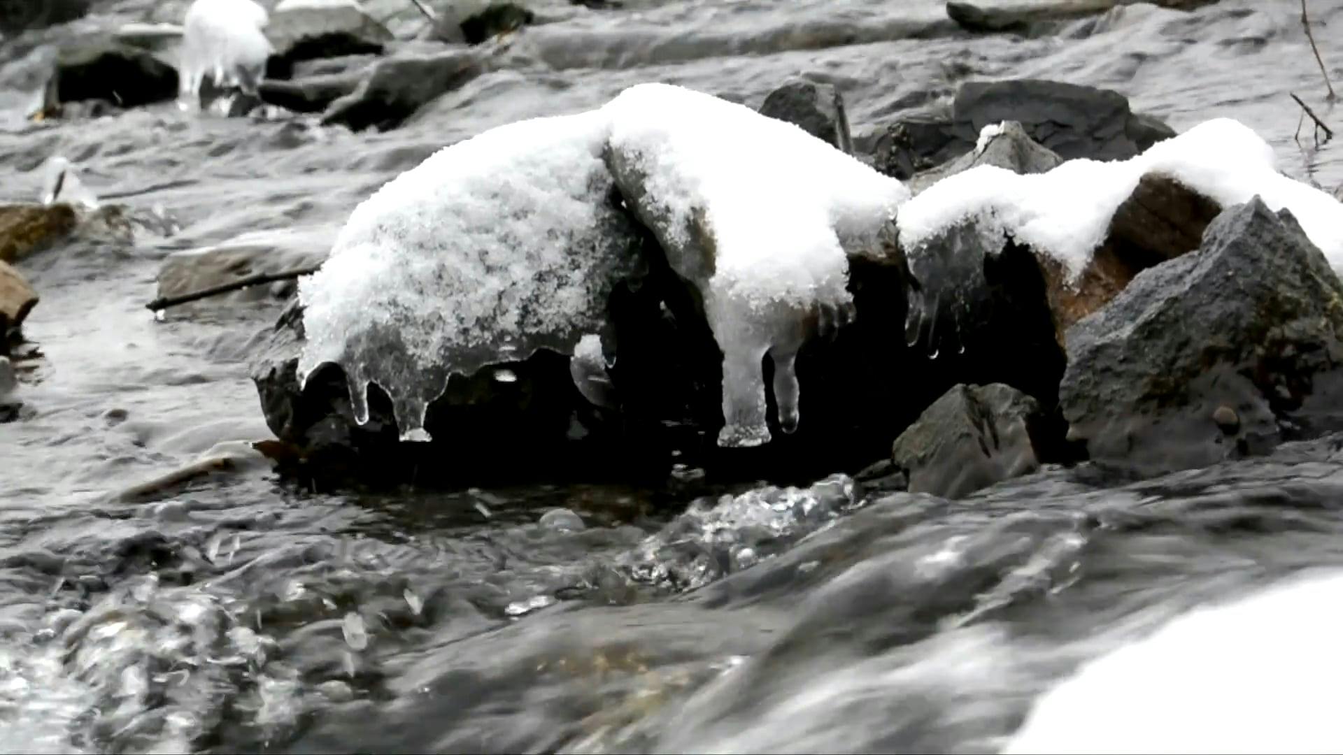Snow Covered Rock in the River · Free Stock Video