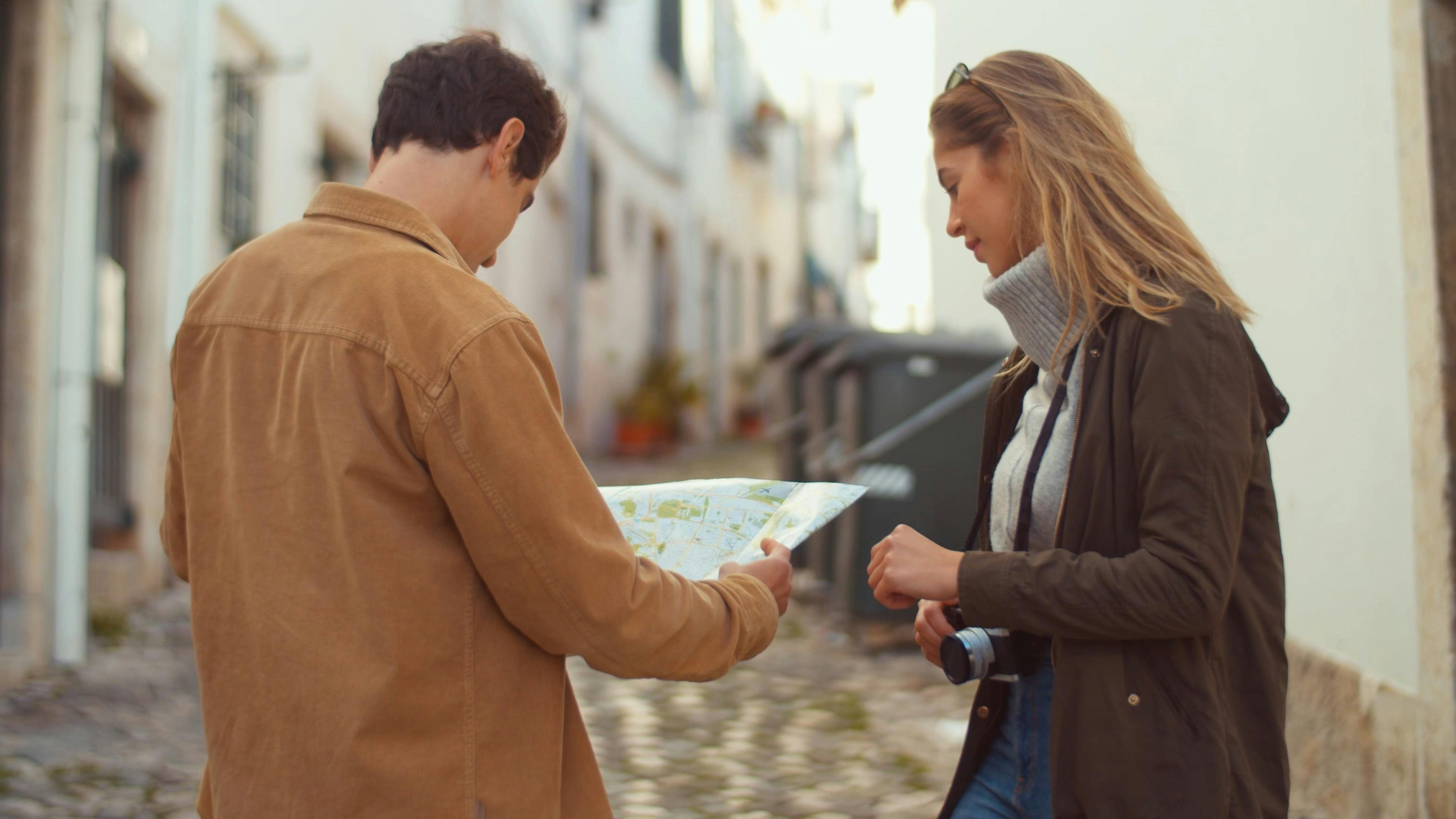 Man Looking at a Compass and a Map for Directions · Free Stock Video