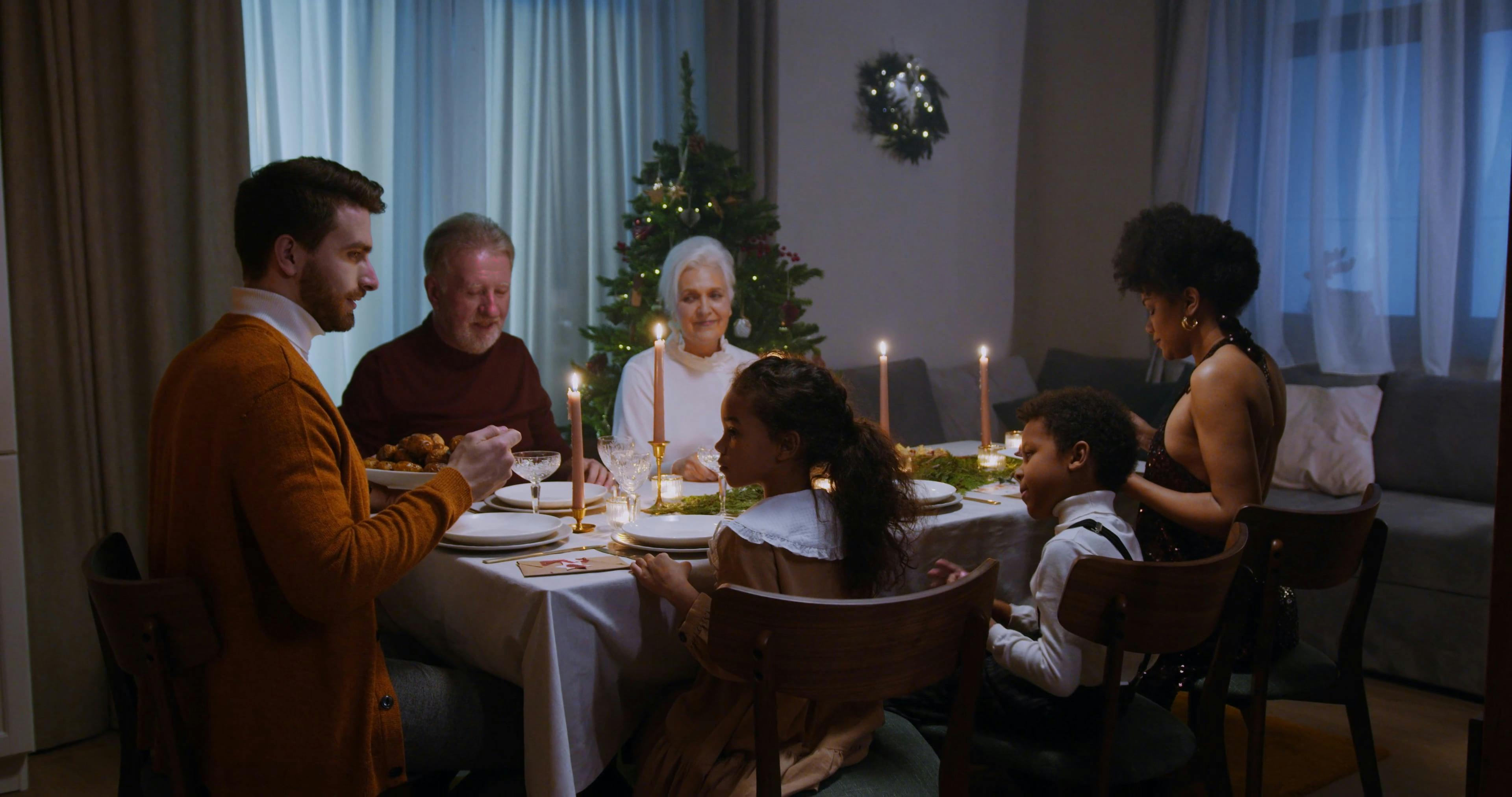 Happy Family Talking at a Dinner Table · Free Stock Video