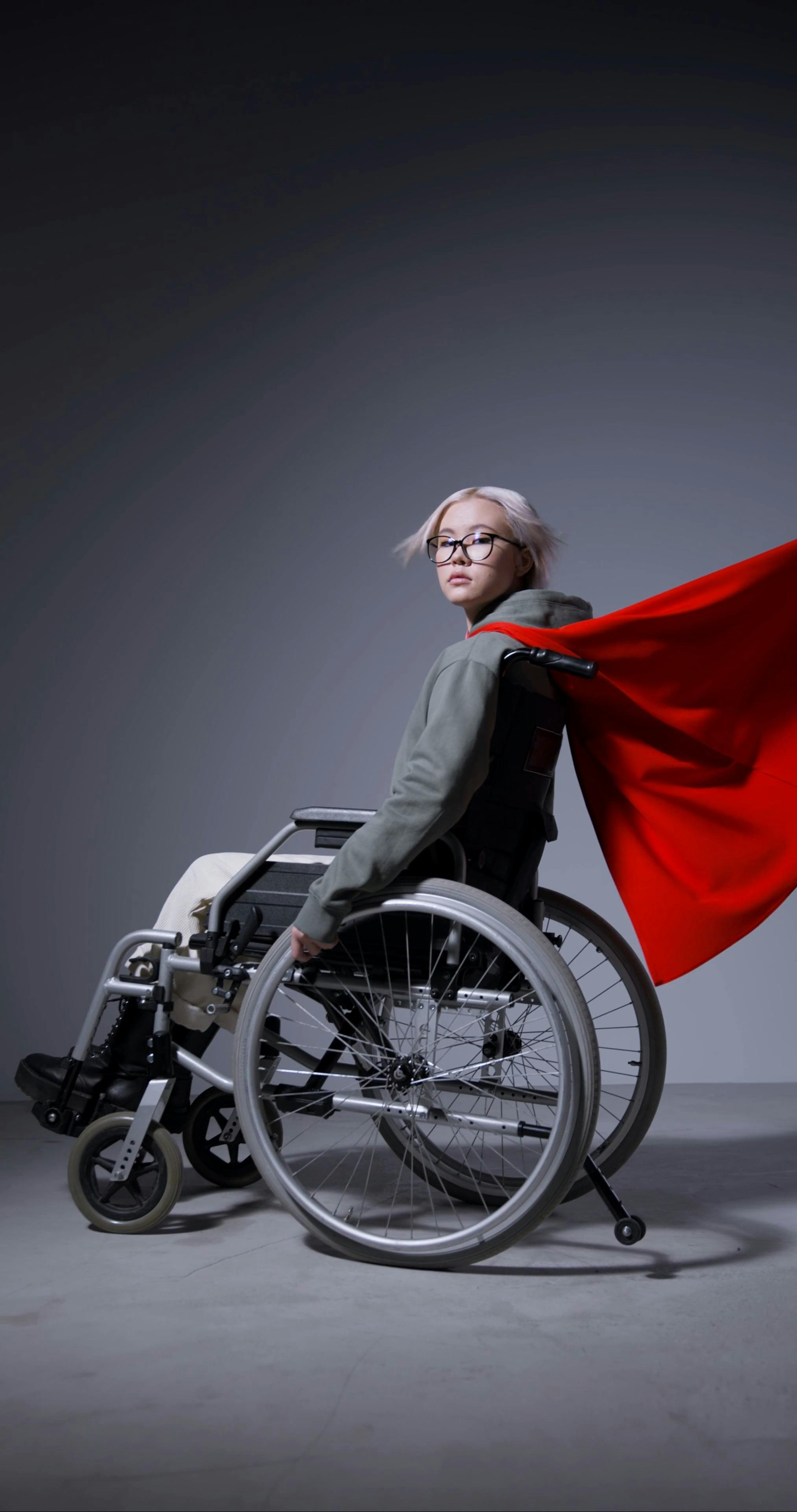 Woman in Superhero Costume in Wheelchair Looking at Camera · Free Stock ...