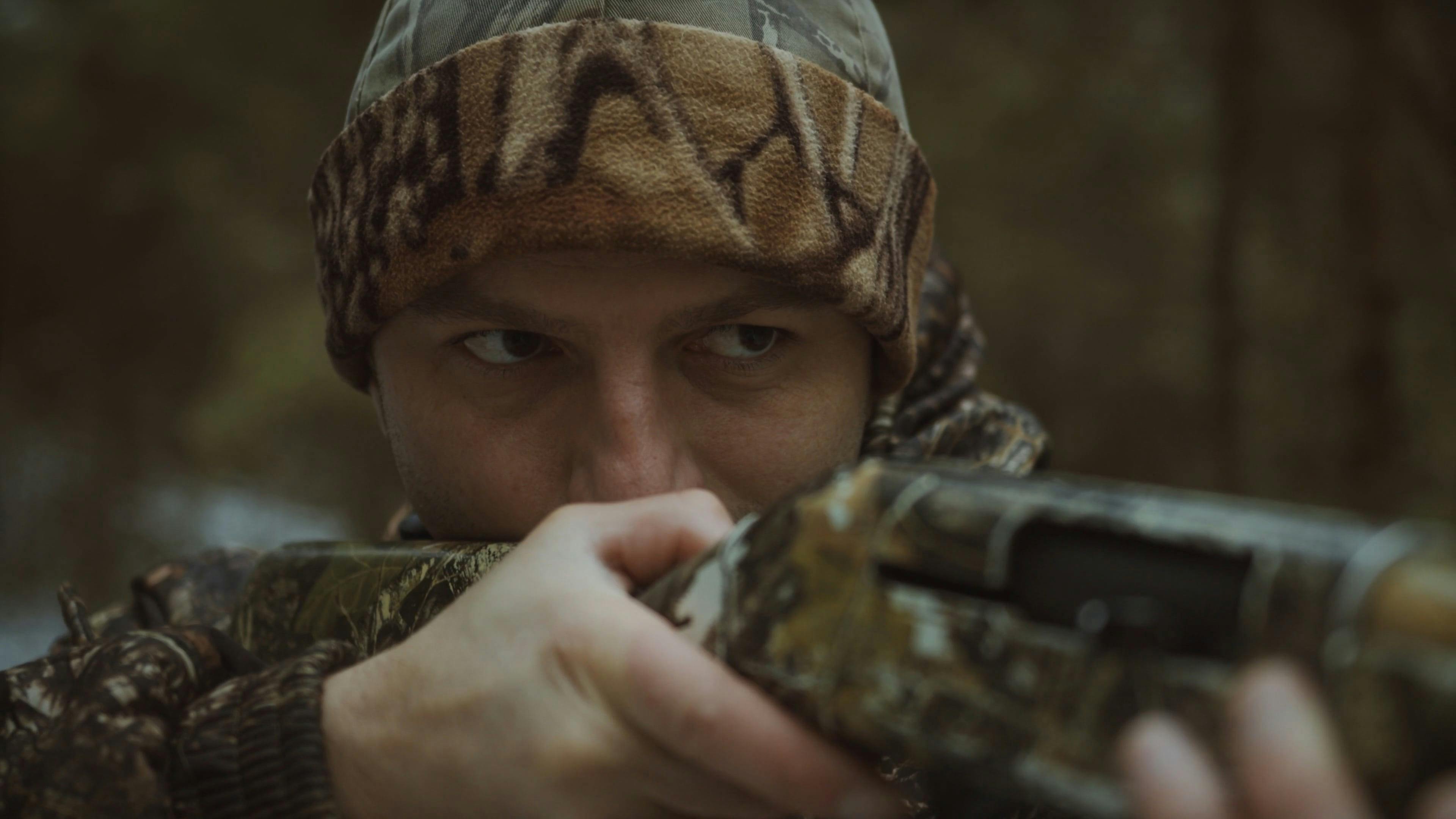 A Man Aiming His Gun while Walking · Free Stock Video