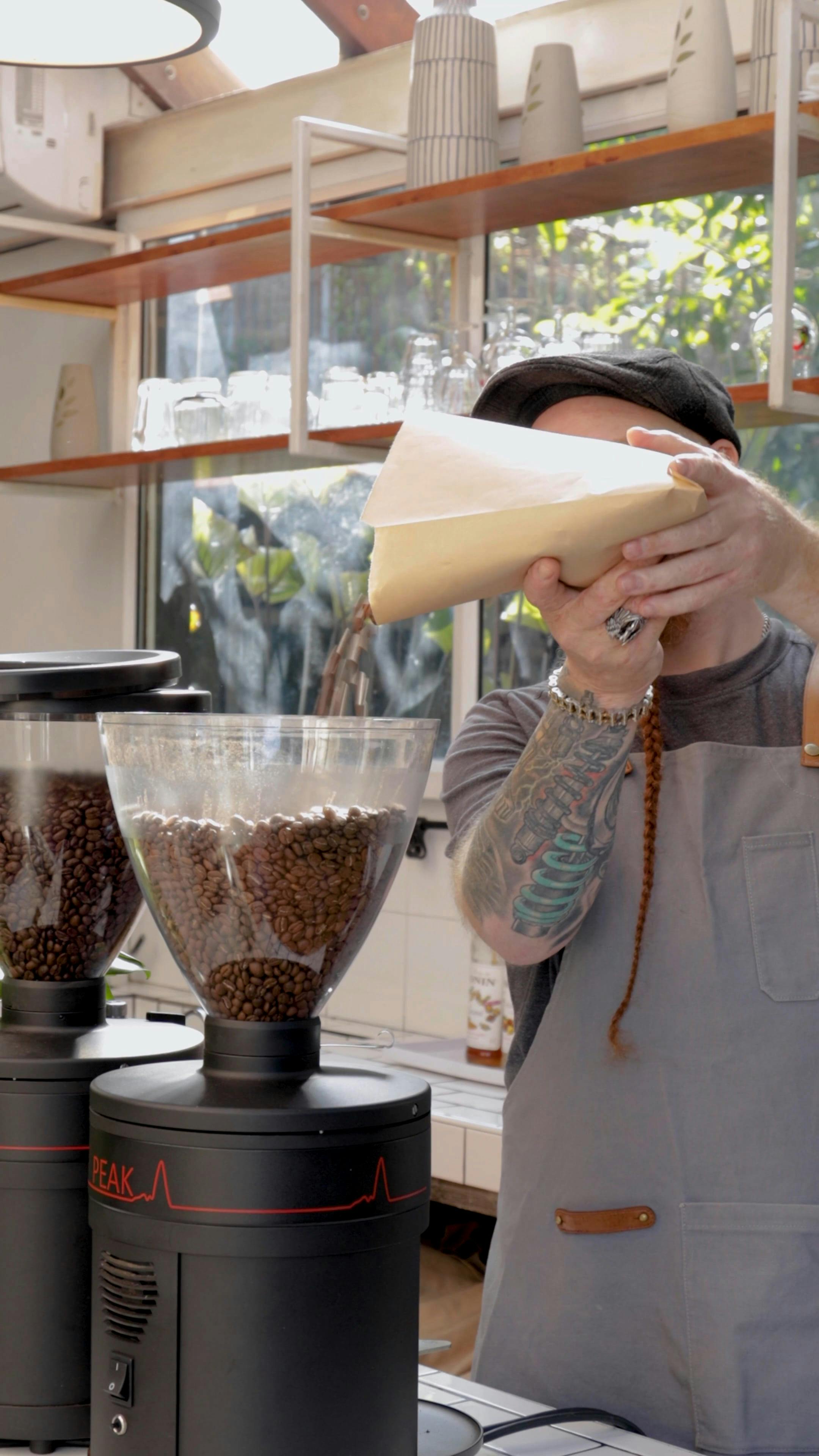 Man Filling Up Machine With Coffee Beans · Free Stock Video