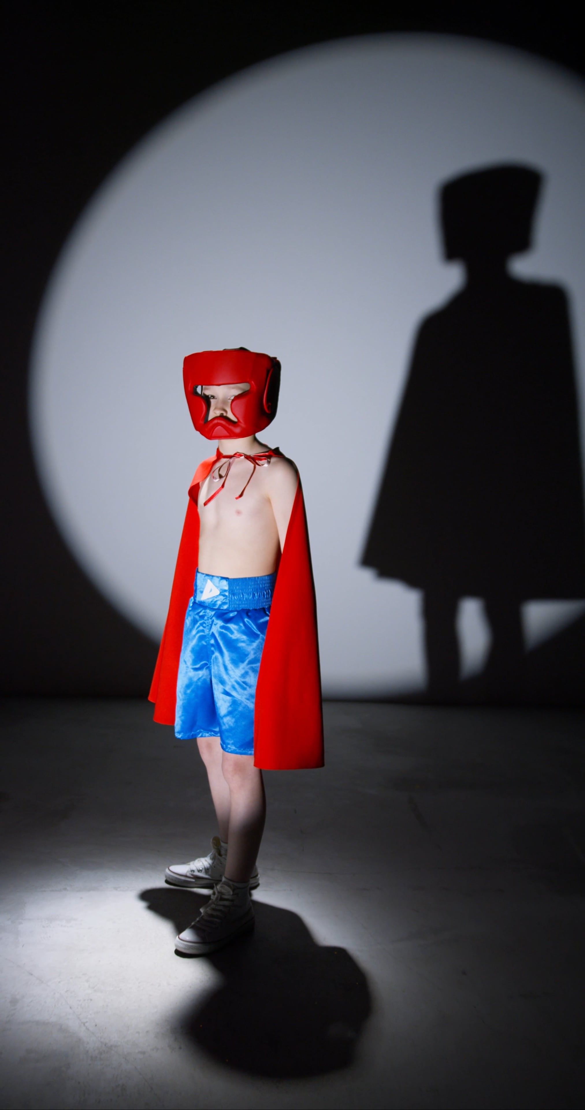A Boy Wearing a Cape Taking off Boxing Headgear Free Stock Video ...