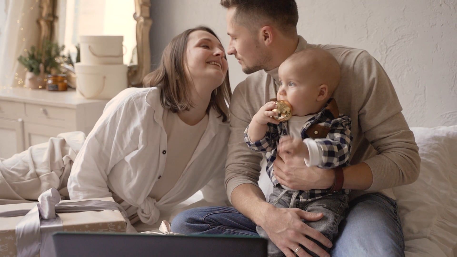 A Couple Kissing While Holding Their Baby · Free Stock Video