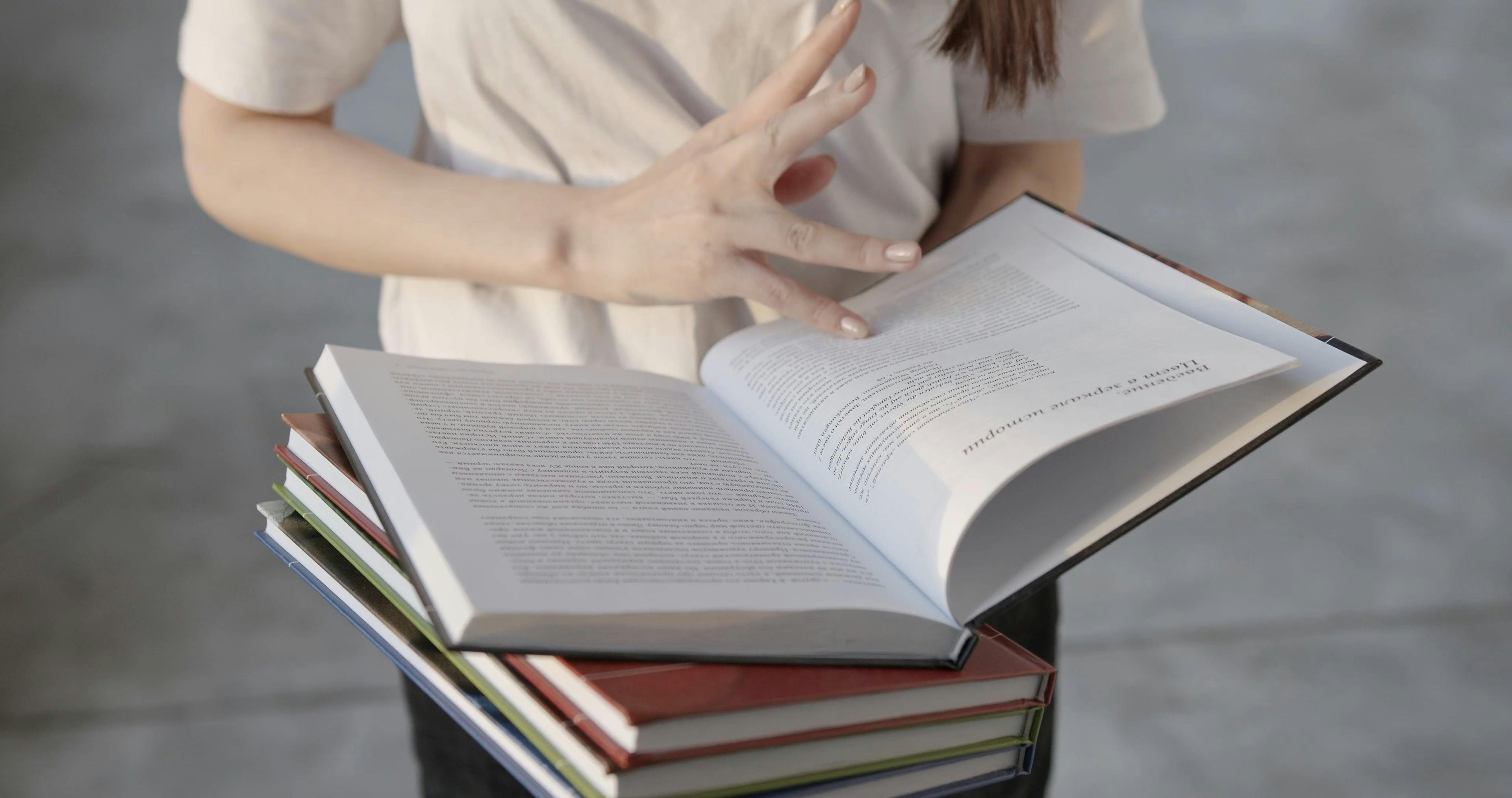 Close Up Video of a Person Holding Books · Free Stock Video