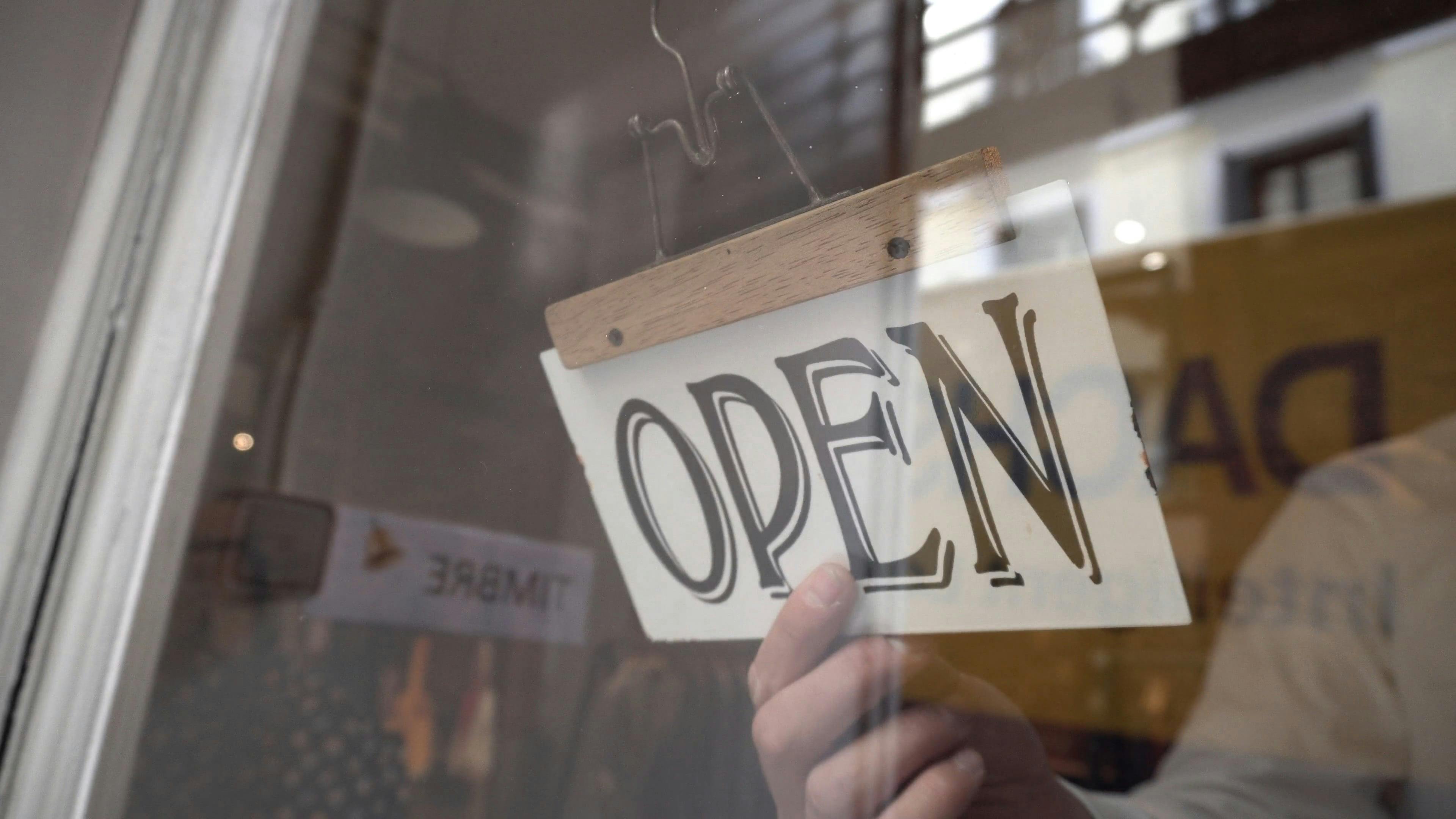 Changing the Open and Close Signage at the Shop · Free Stock Video