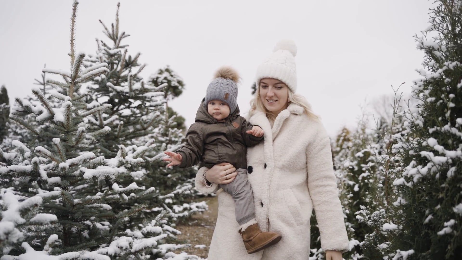A Woman Carrying a Baby While Walking · Free Stock Video