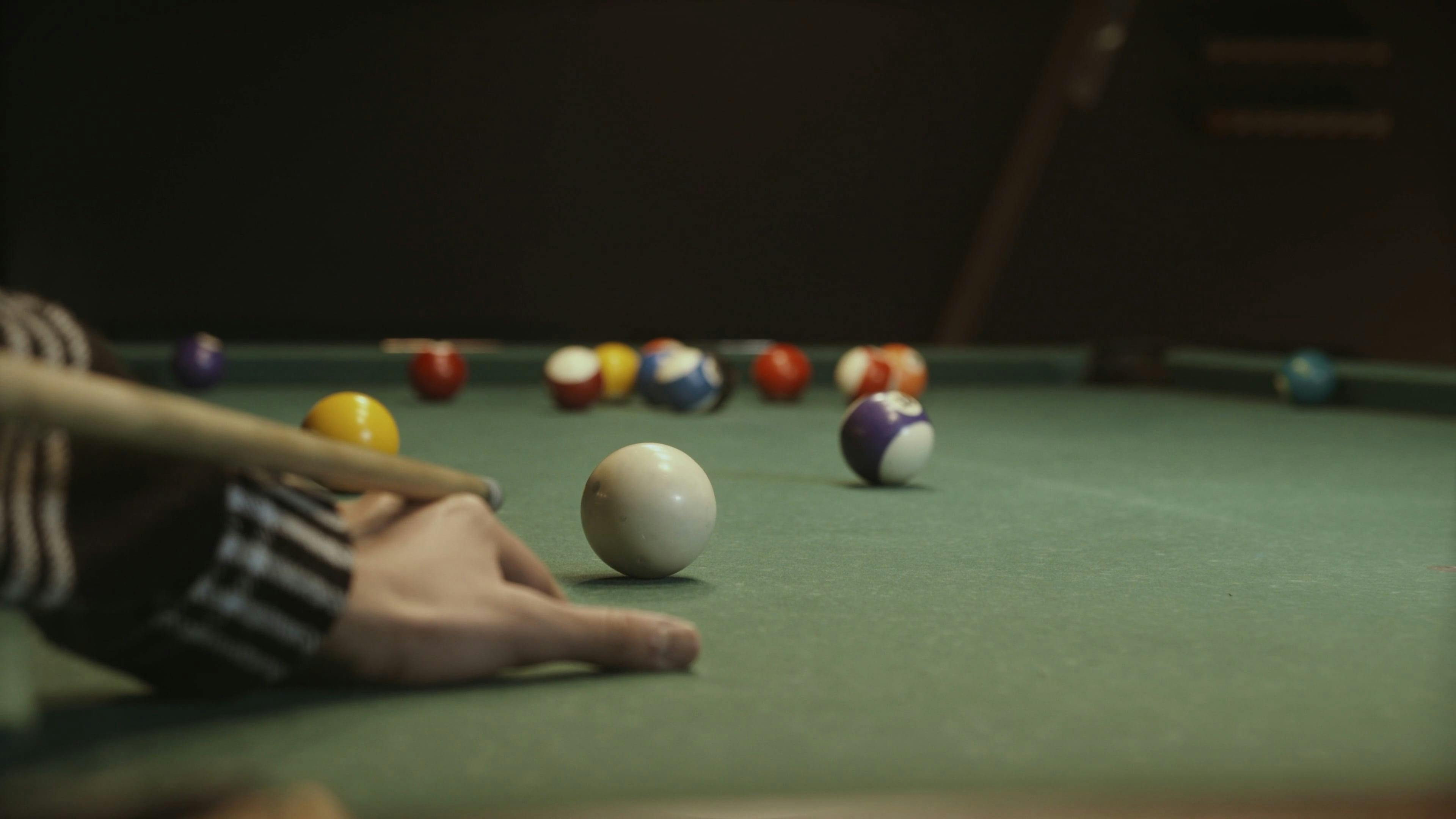 Person Hitting the Billiard Ball Using a Cue Stick Free Stock Video ...