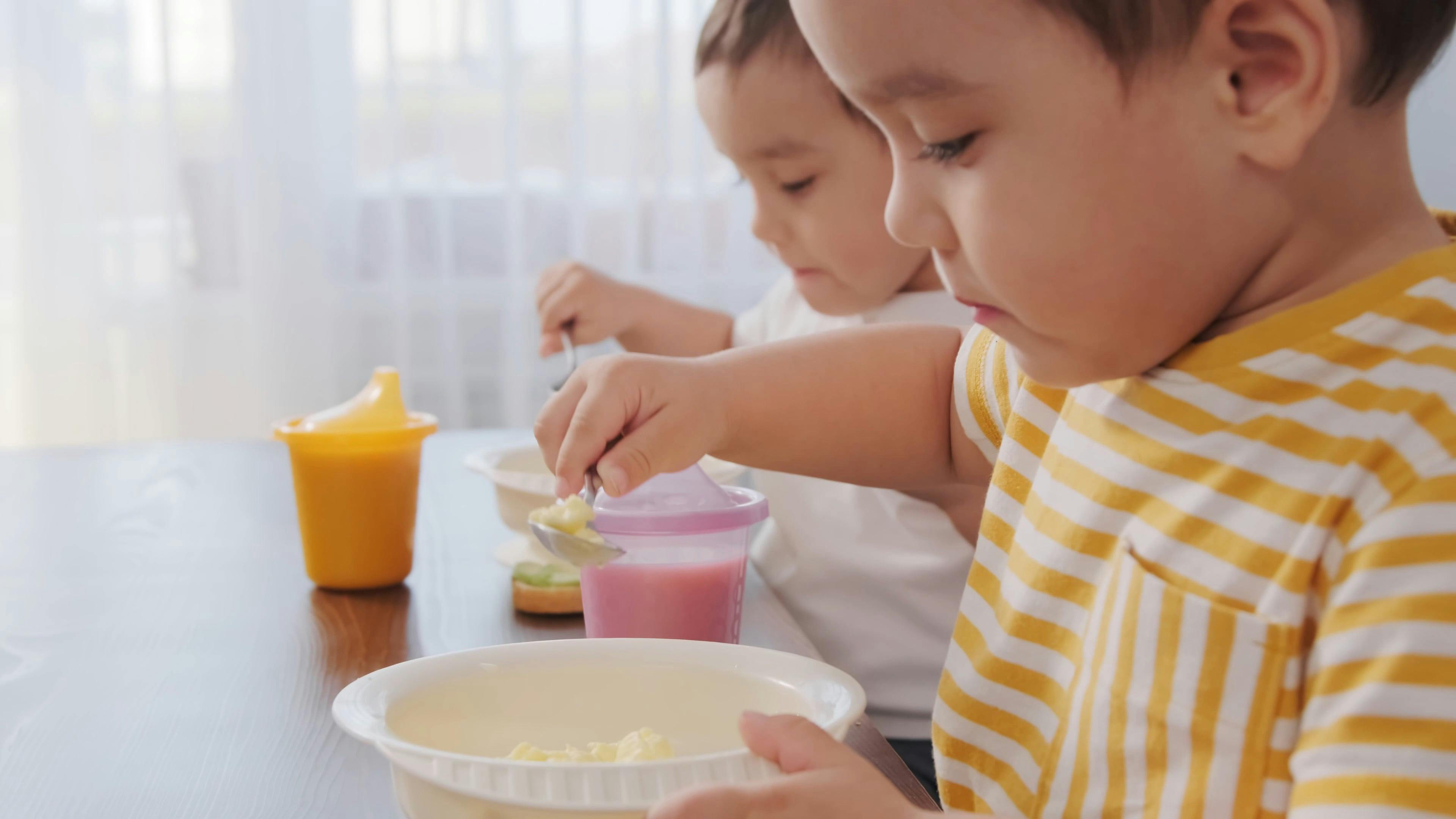 Close Up View of Twin Brothers Eating Breakfast Free Stock Video ...