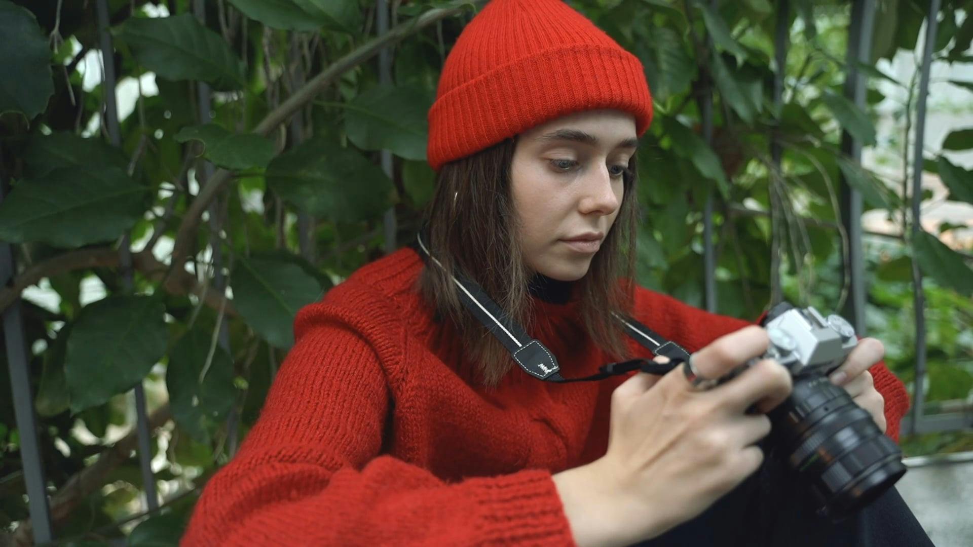 A Photographer Looking at Her Camera · Free Stock Video