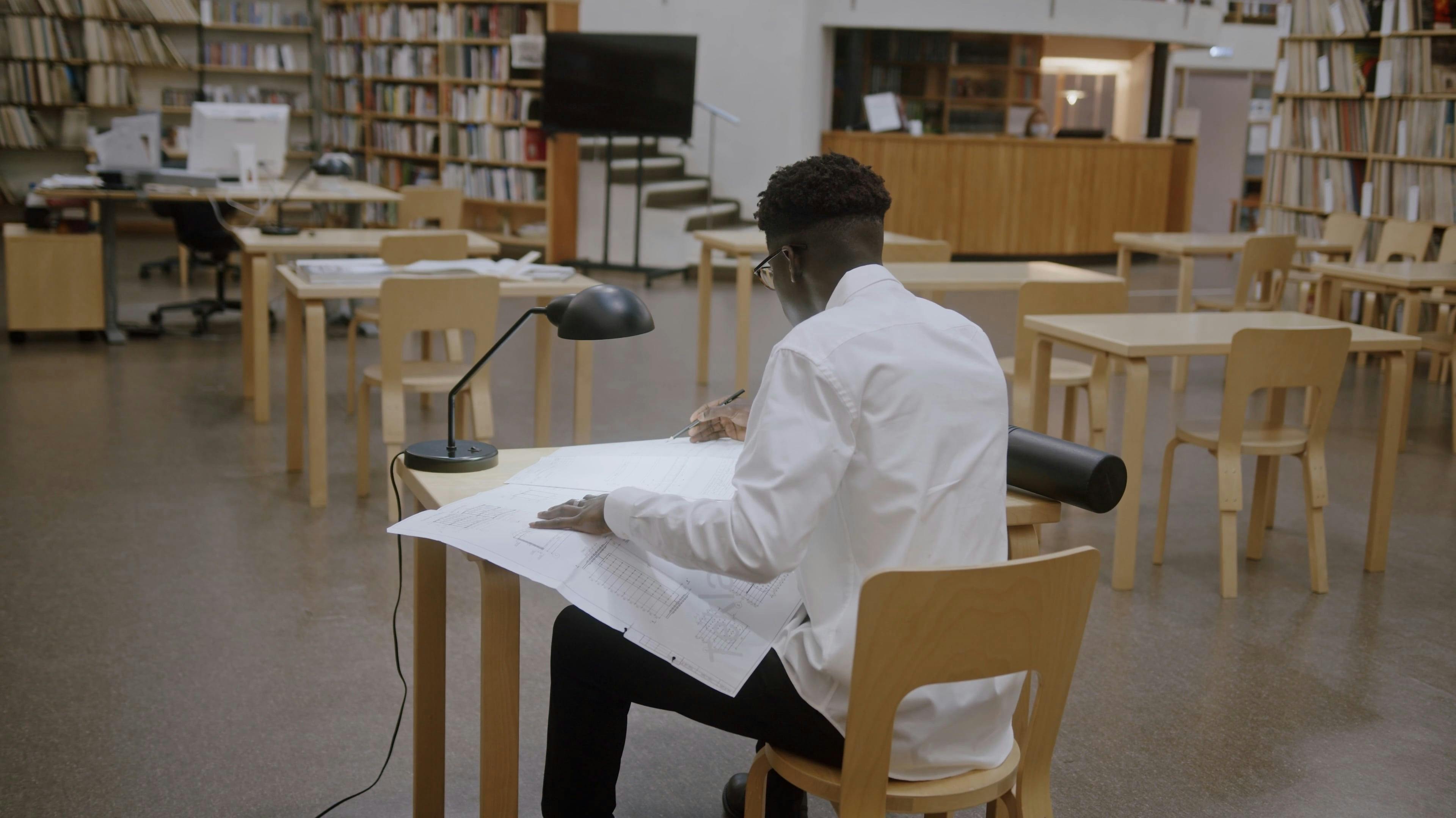 Young Male Student Sitting Alone in Library · Free Stock Video