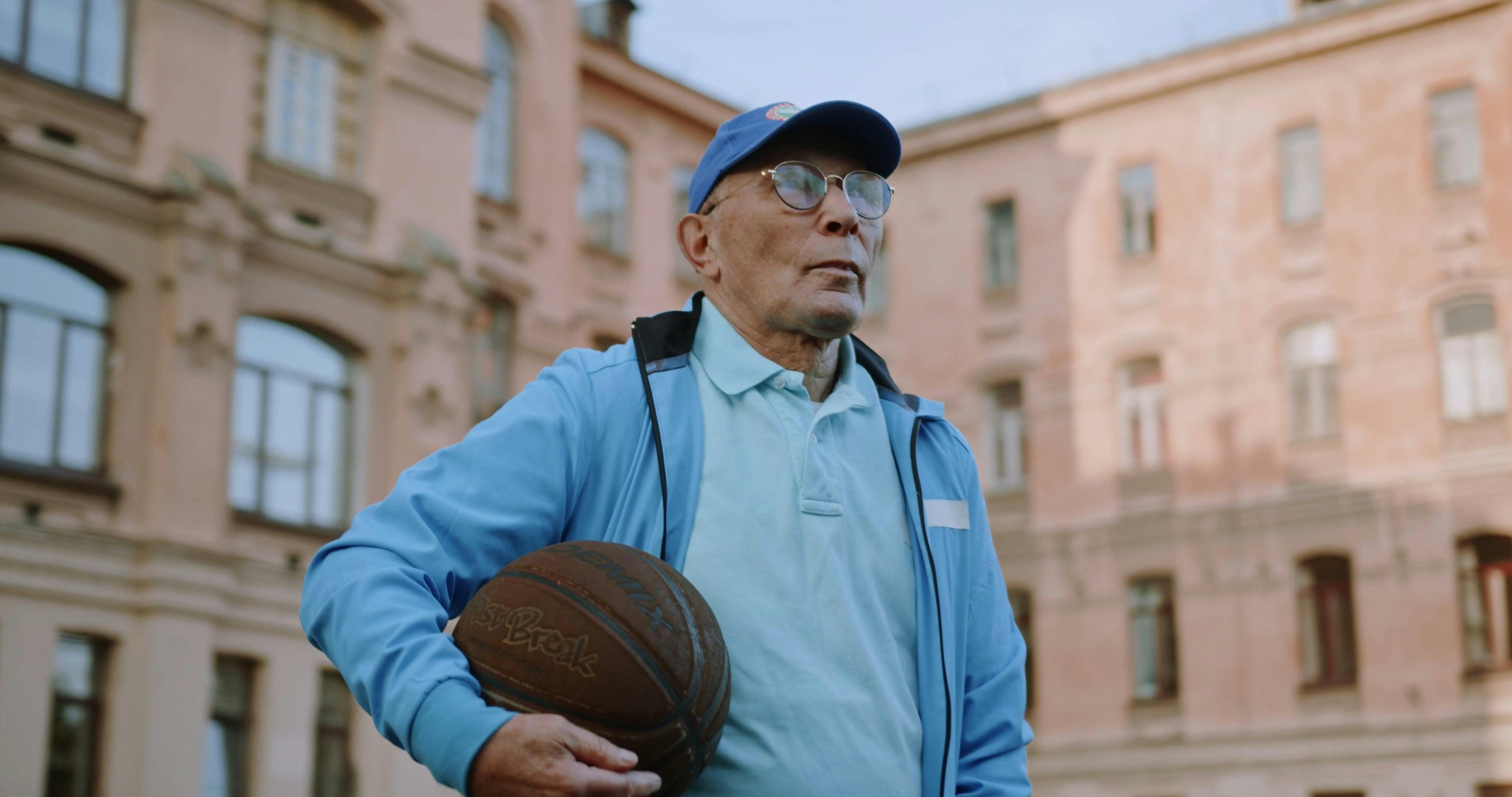 An Elderly Man Holding a Ball while Looking at the Camera · Free Stock ...