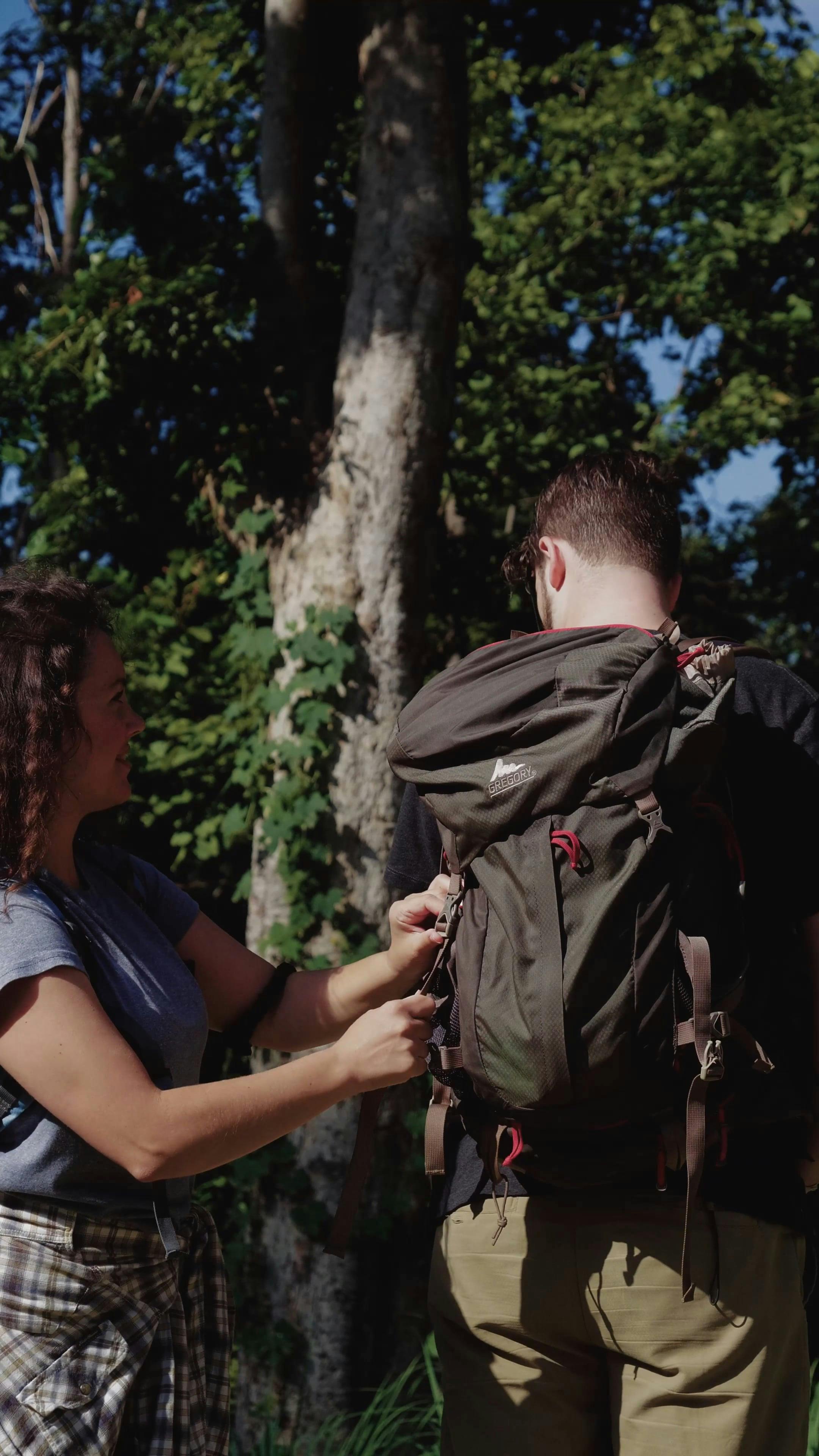 Woman Helping her Boyfriend to Fasten his Backpack Free Stock Video ...