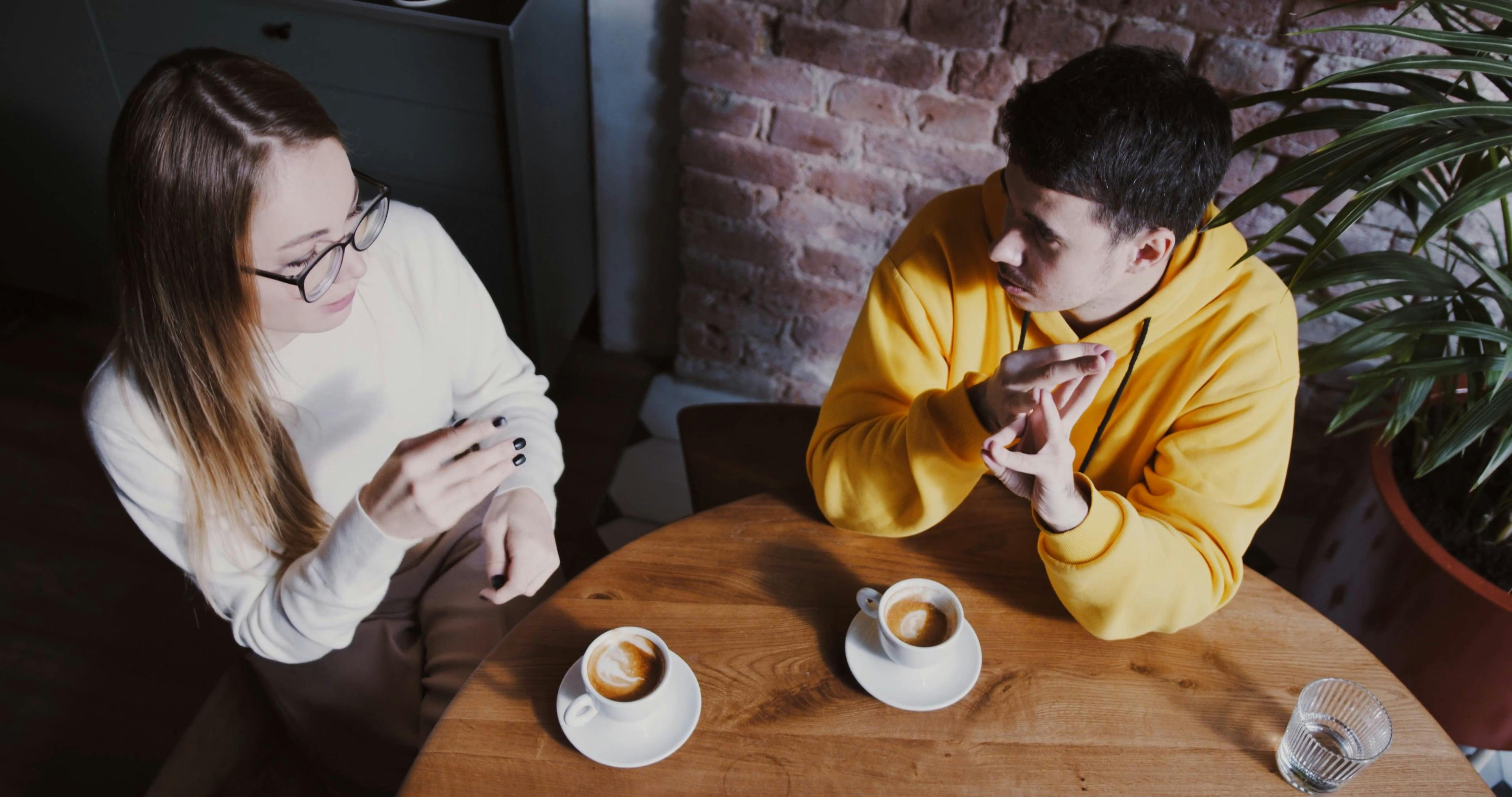 Man and a Woman in a Café Communicating in Sign Language Free Stock ...