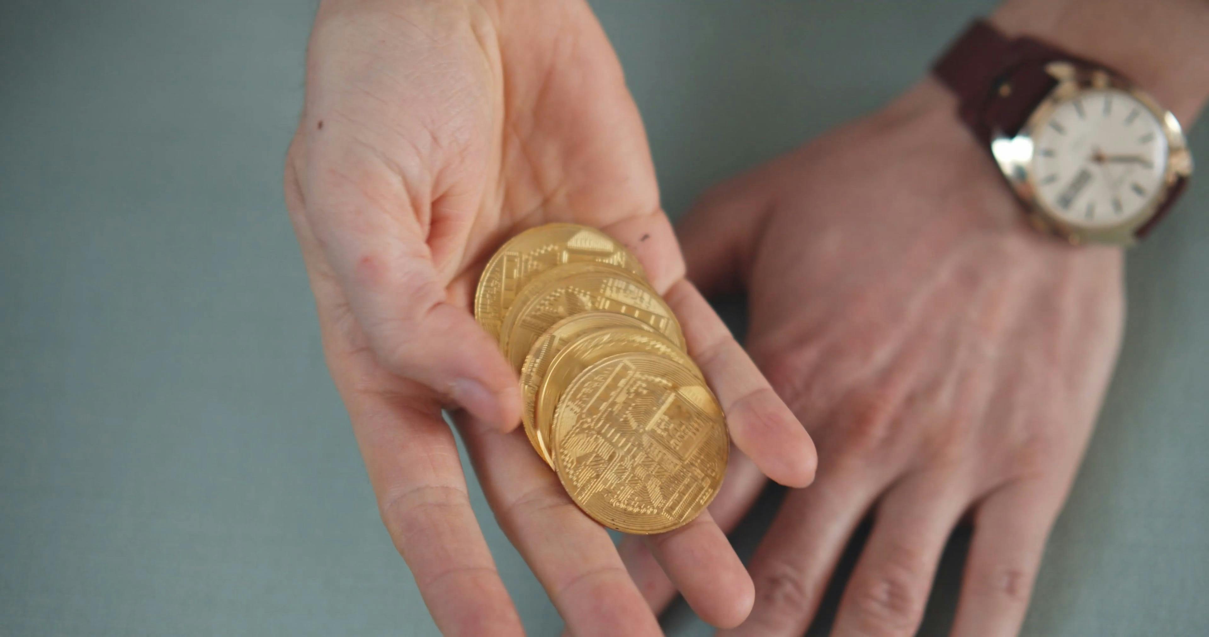 Close Up of a Hand Holding Gold Coins · Free Stock Video